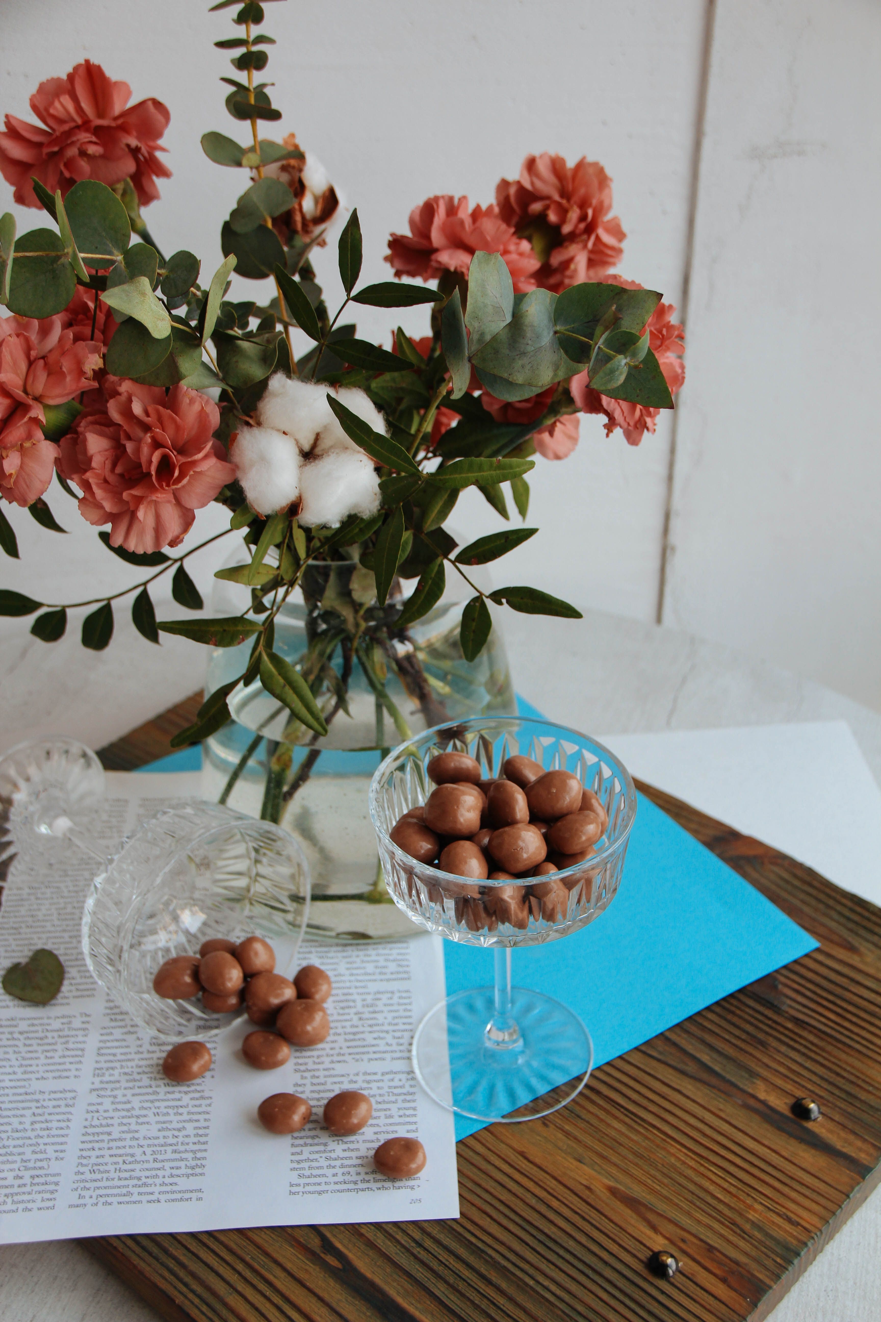 Nuts by Flowers in Vase · Free Stock Photo