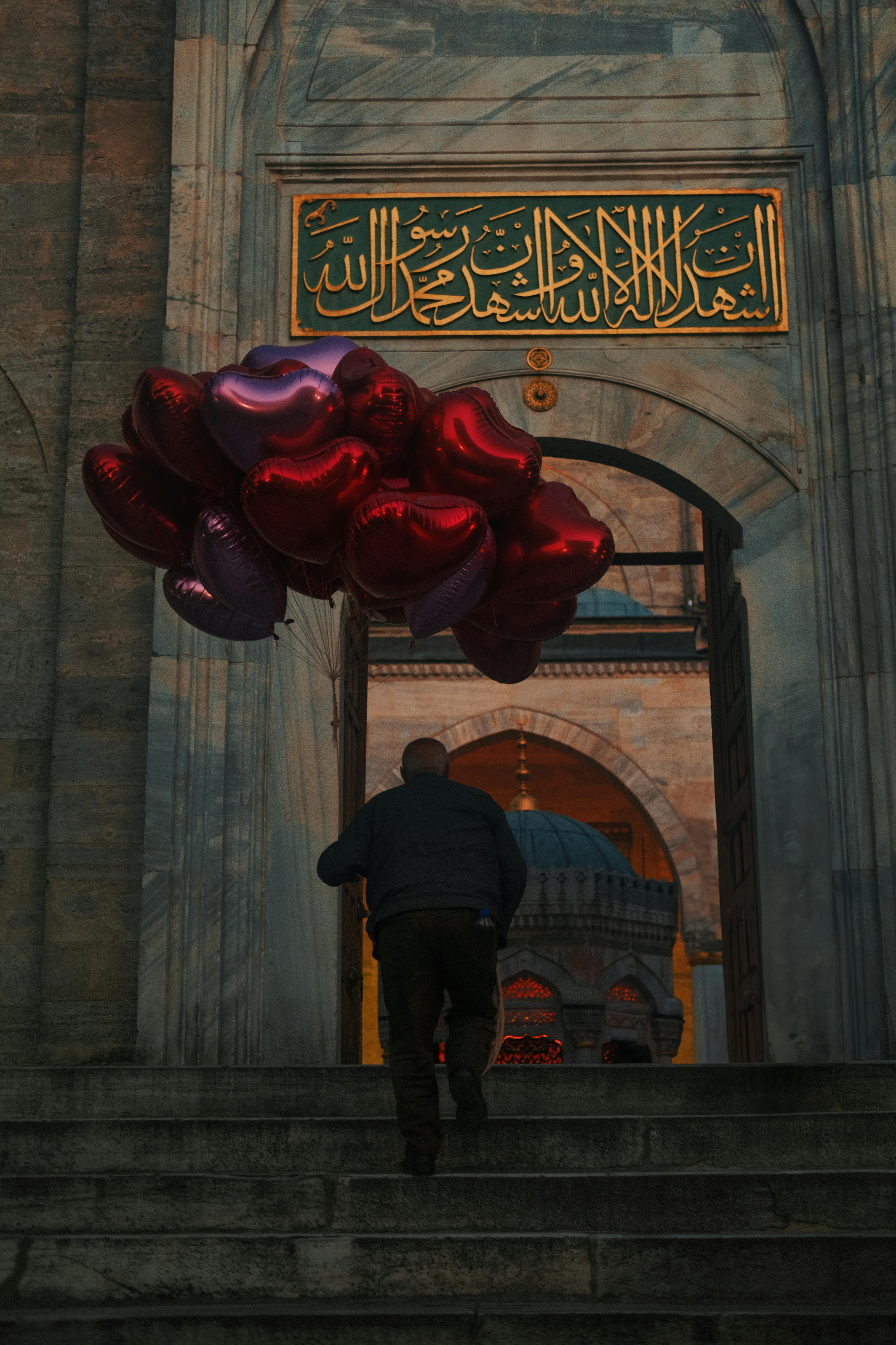 Pink Heart Shape Balloons in Front of a Gate with an Arabic Script ...