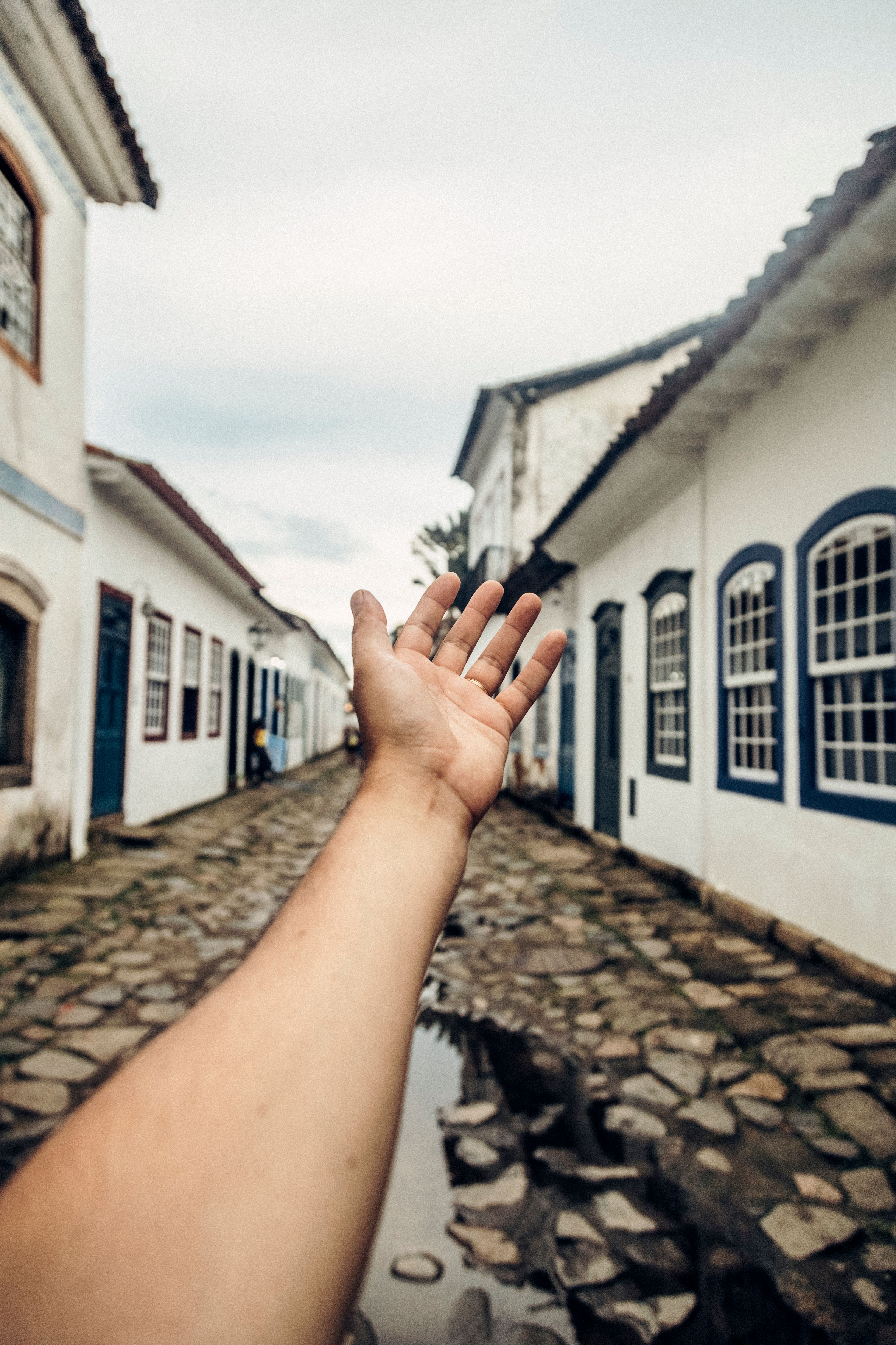 Person Reaching Out in Town · Free Stock Photo