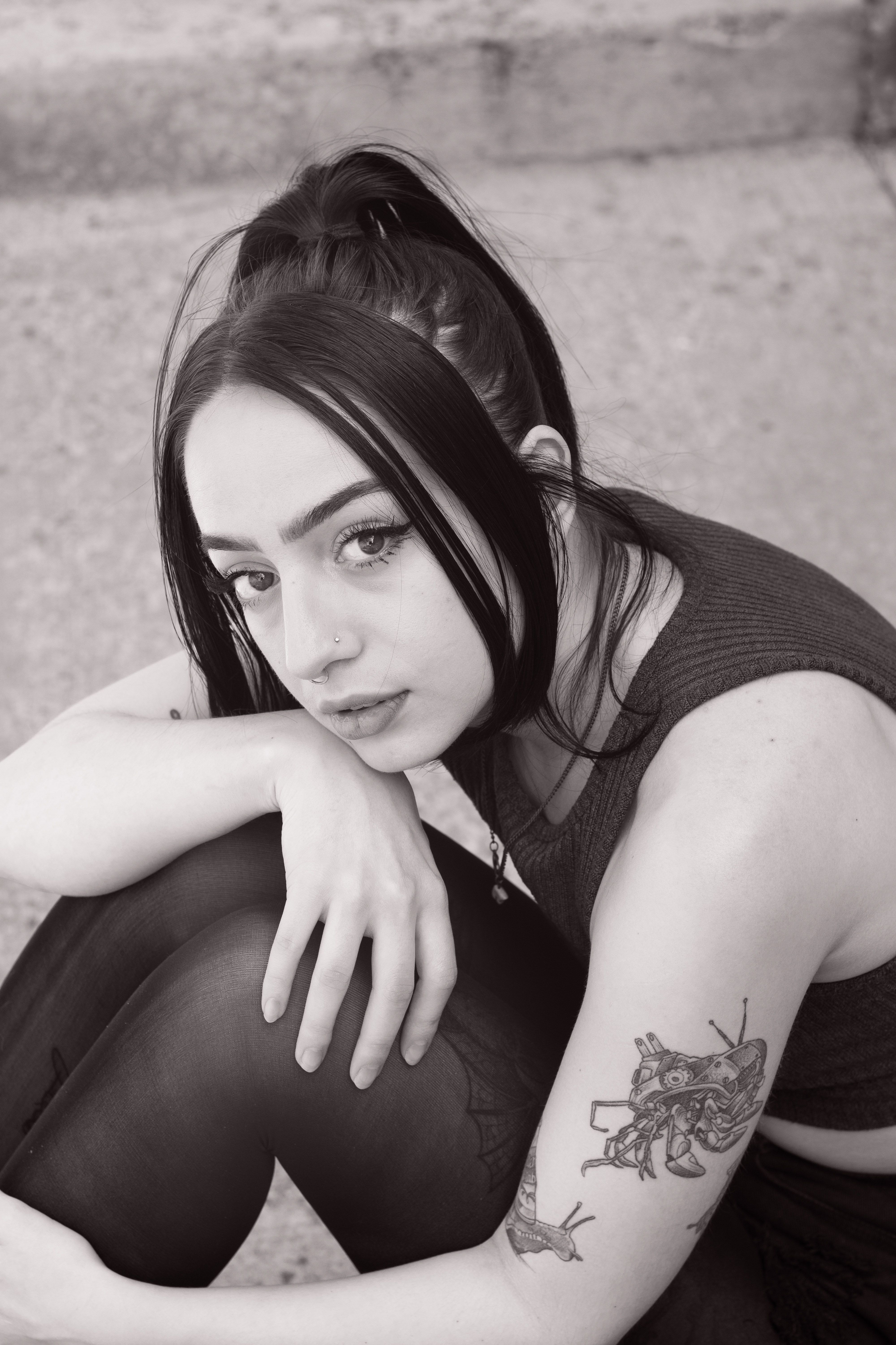 Woman with Tattoos Sitting and Posing · Free Stock Photo