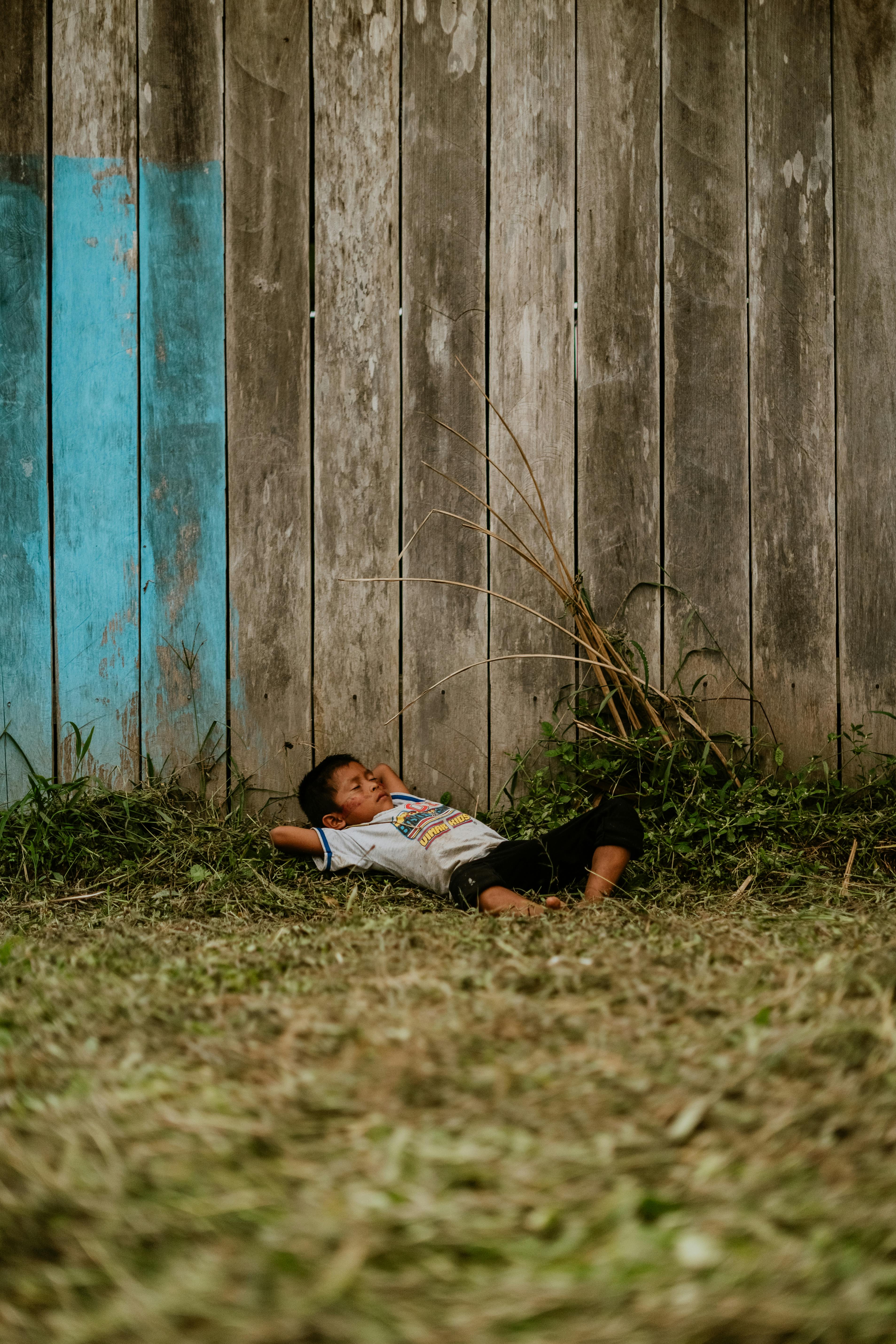 A Boy Sleeping in Grass · Free Stock Photo