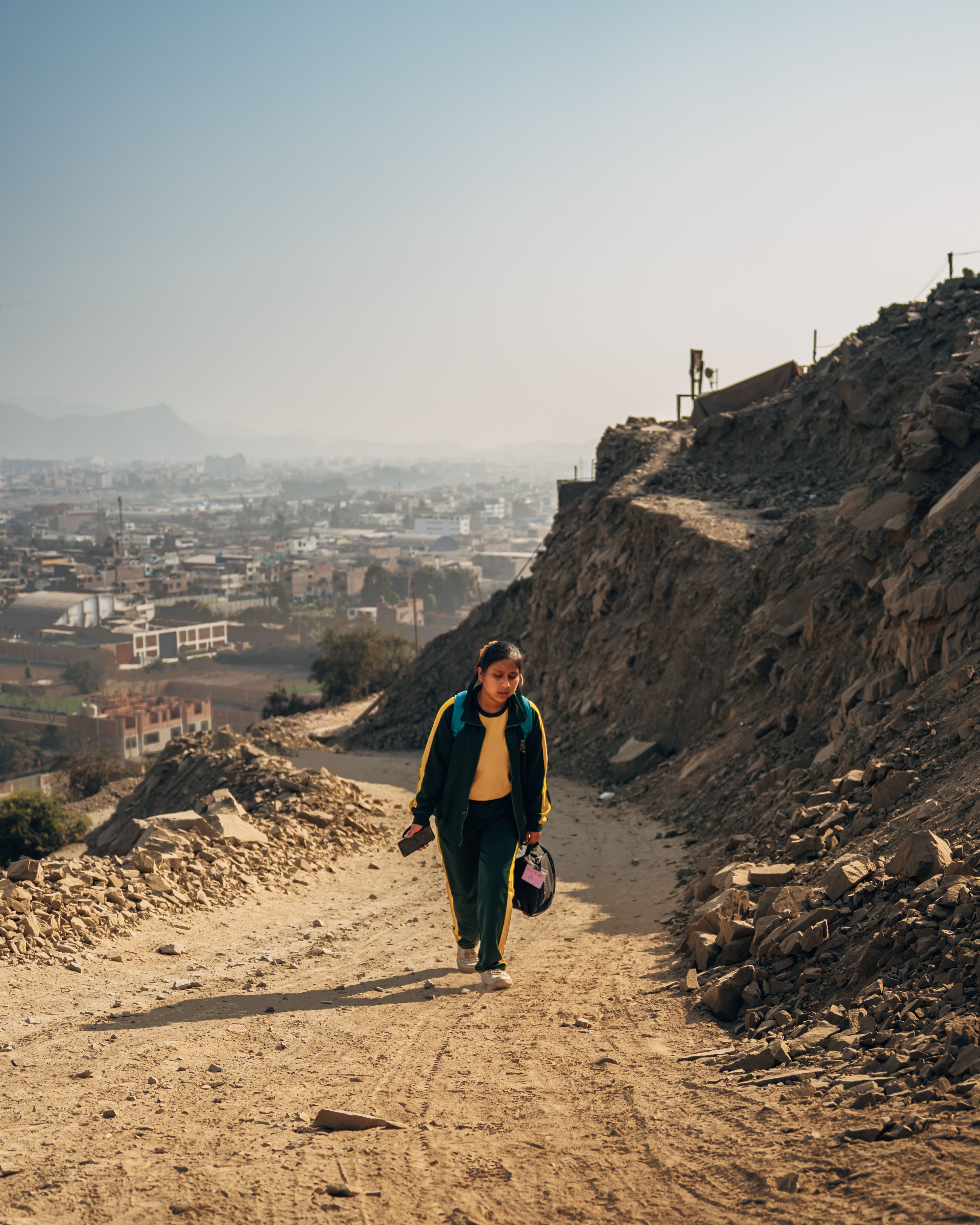 Girl Climbing Sunlit Hill · Free Stock Photo
