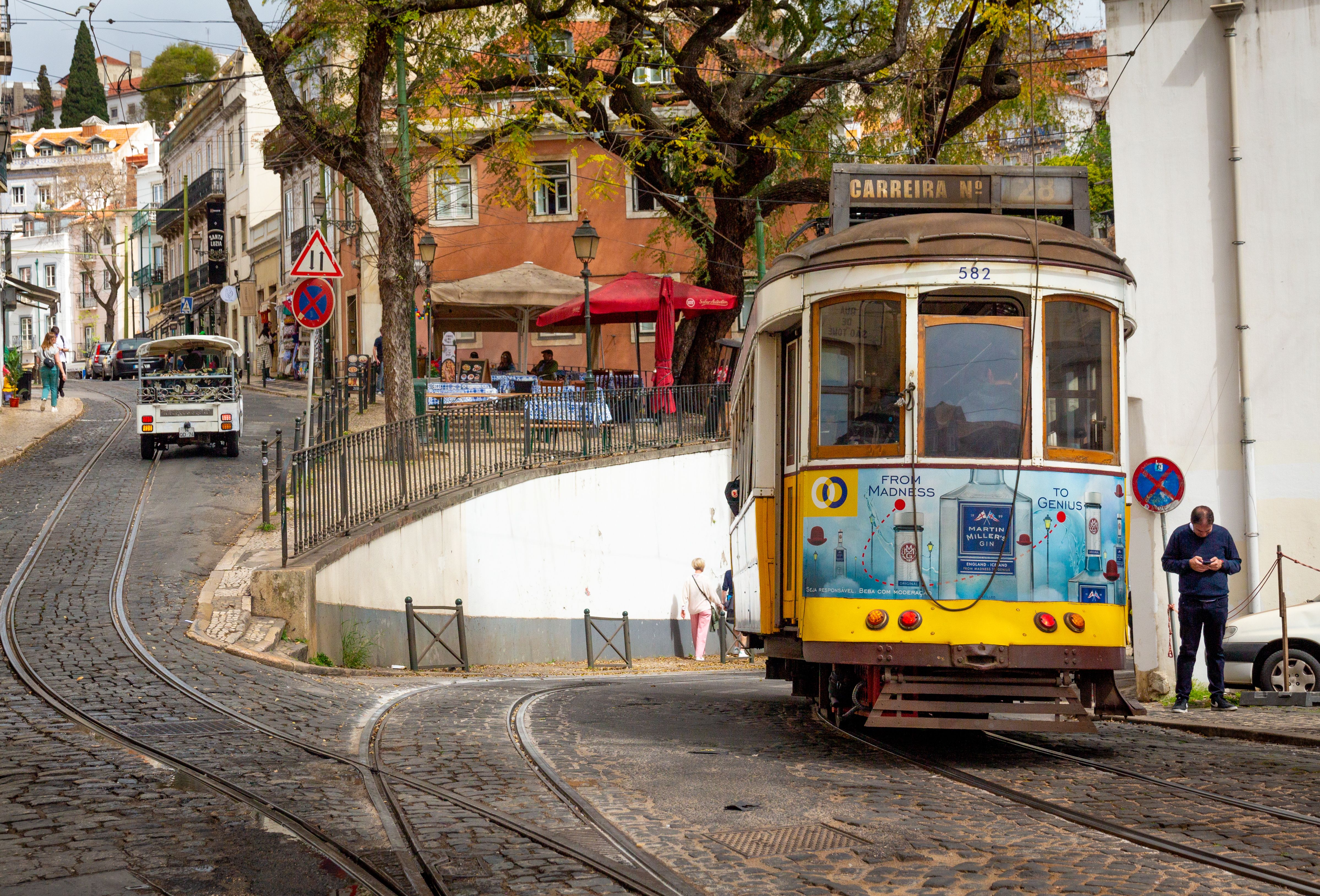 Old Tram Driving through Cobblestone City Street · Free Stock Photo