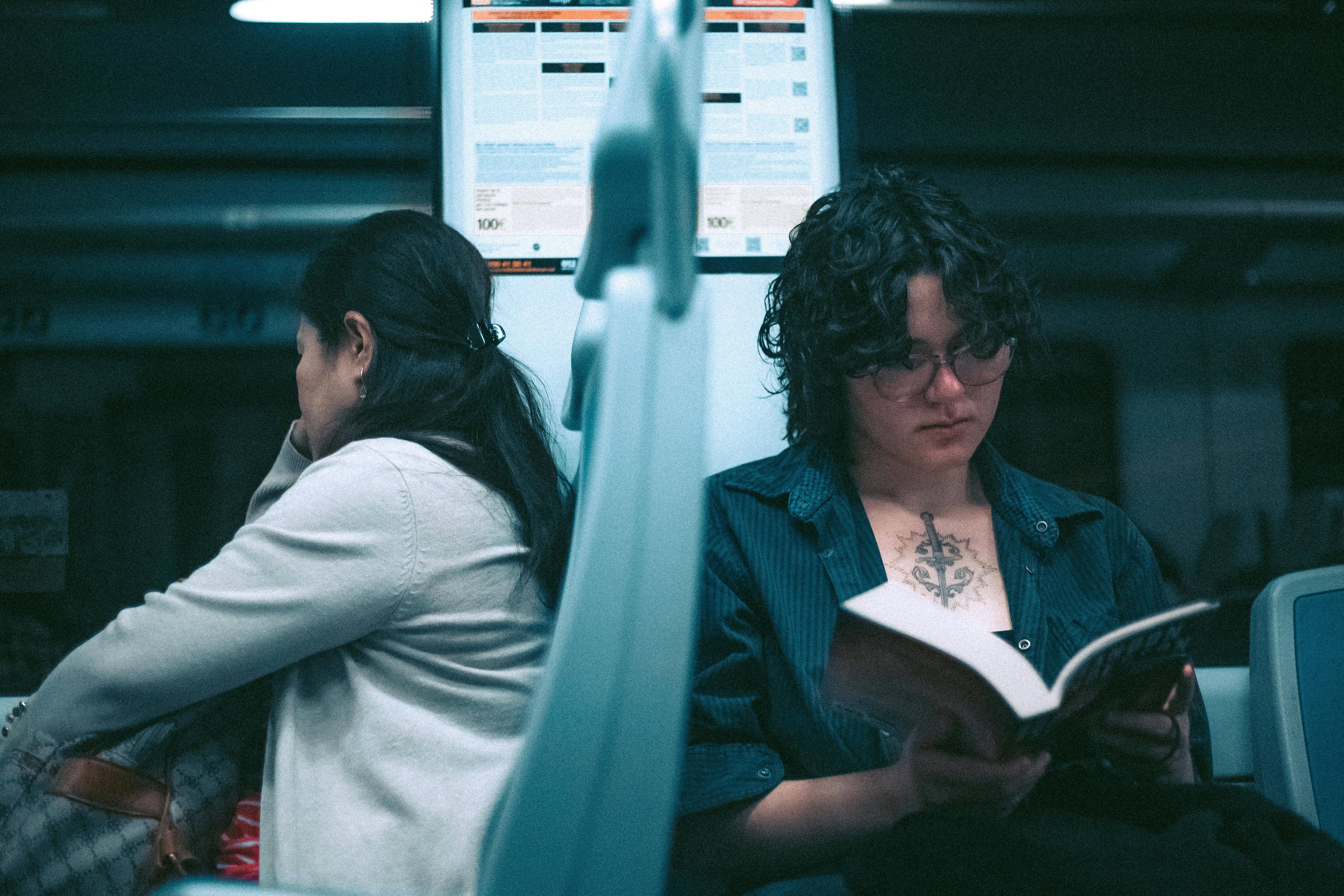 Brunette Reading Book on Bus · Free Stock Photo