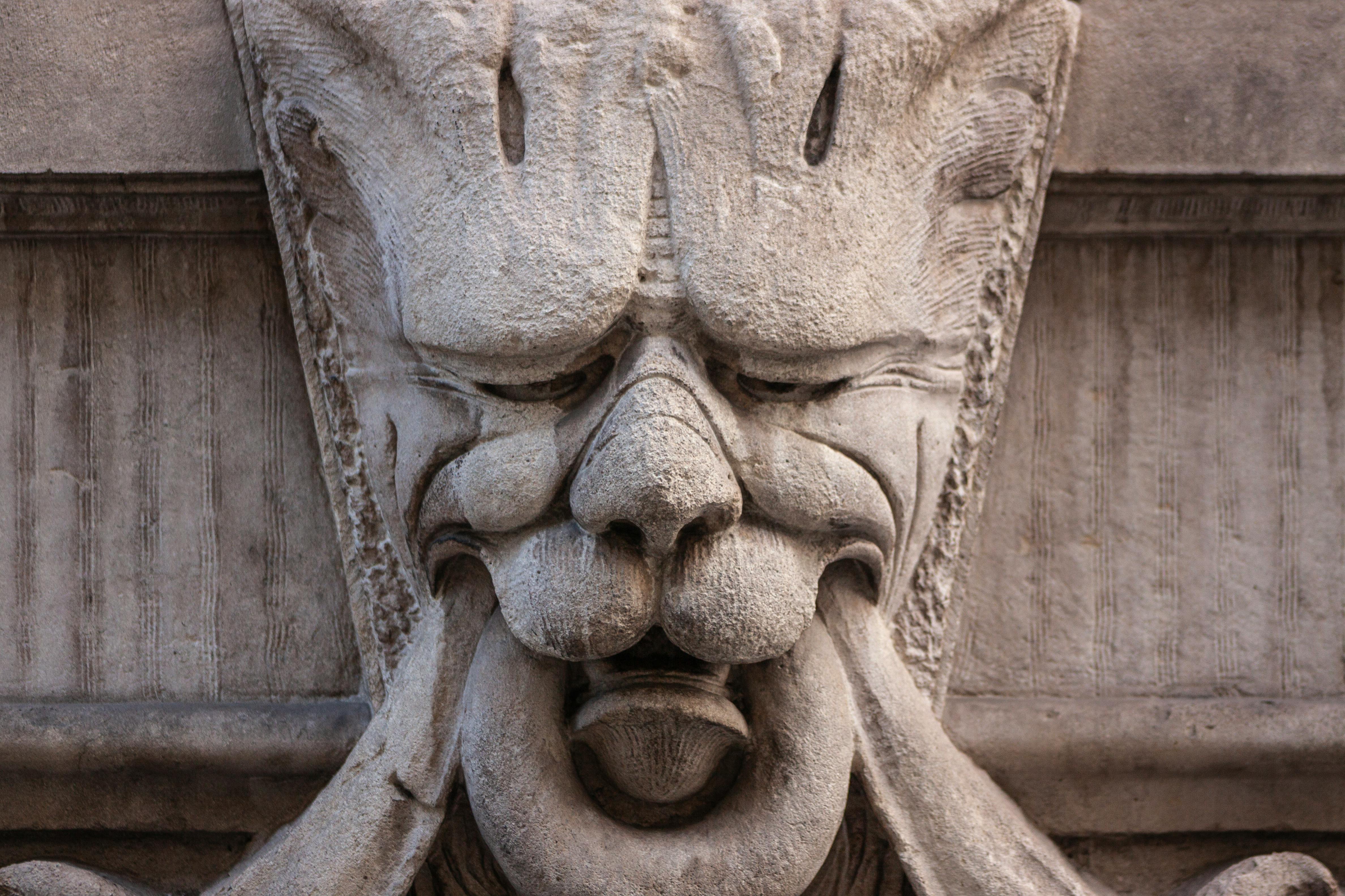 Close-up of a Statue Carved on a Wall of a Building · Free Stock Photo