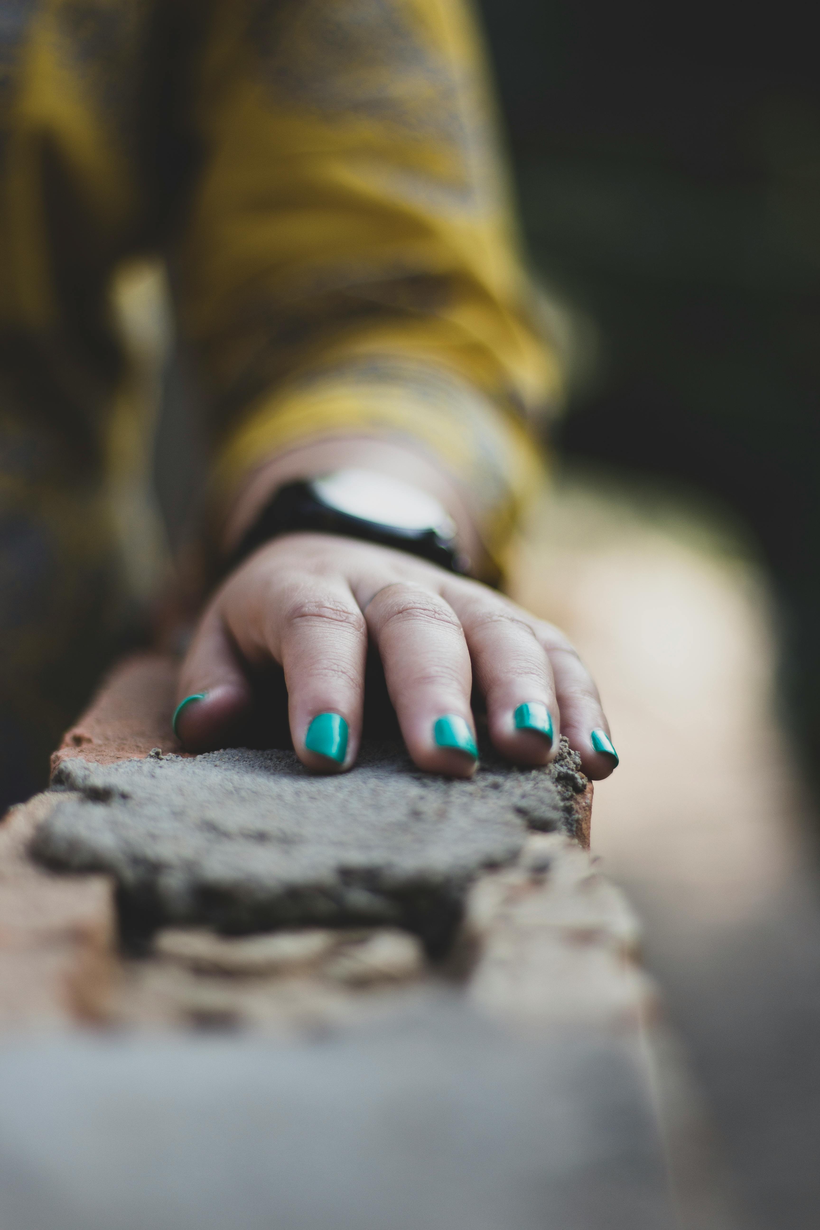 Woman's Hands Resting on Concrete Surface · Free Stock Photo