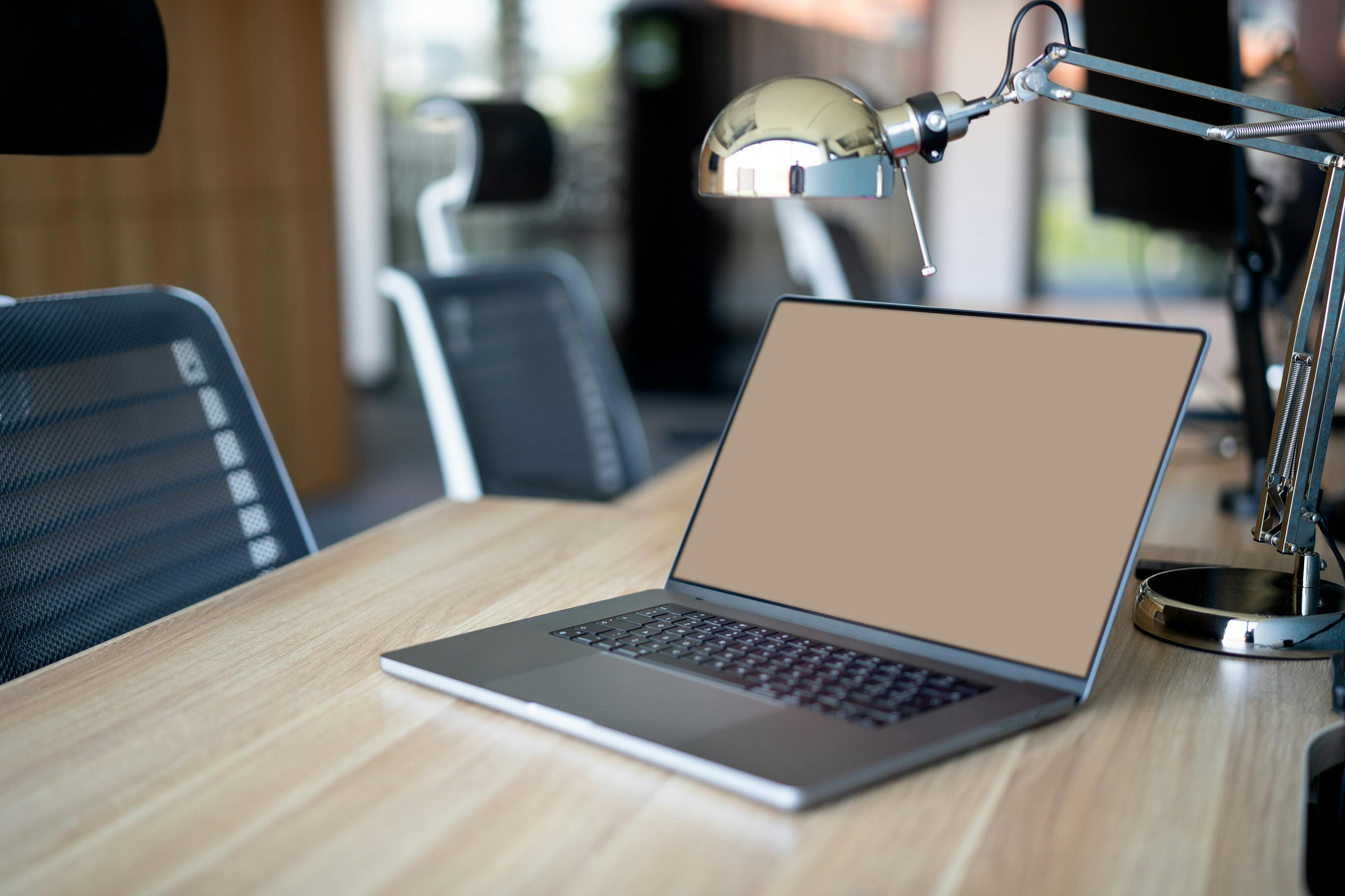 Laptop lying on the desk. Office spaces. · Free Stock Photo