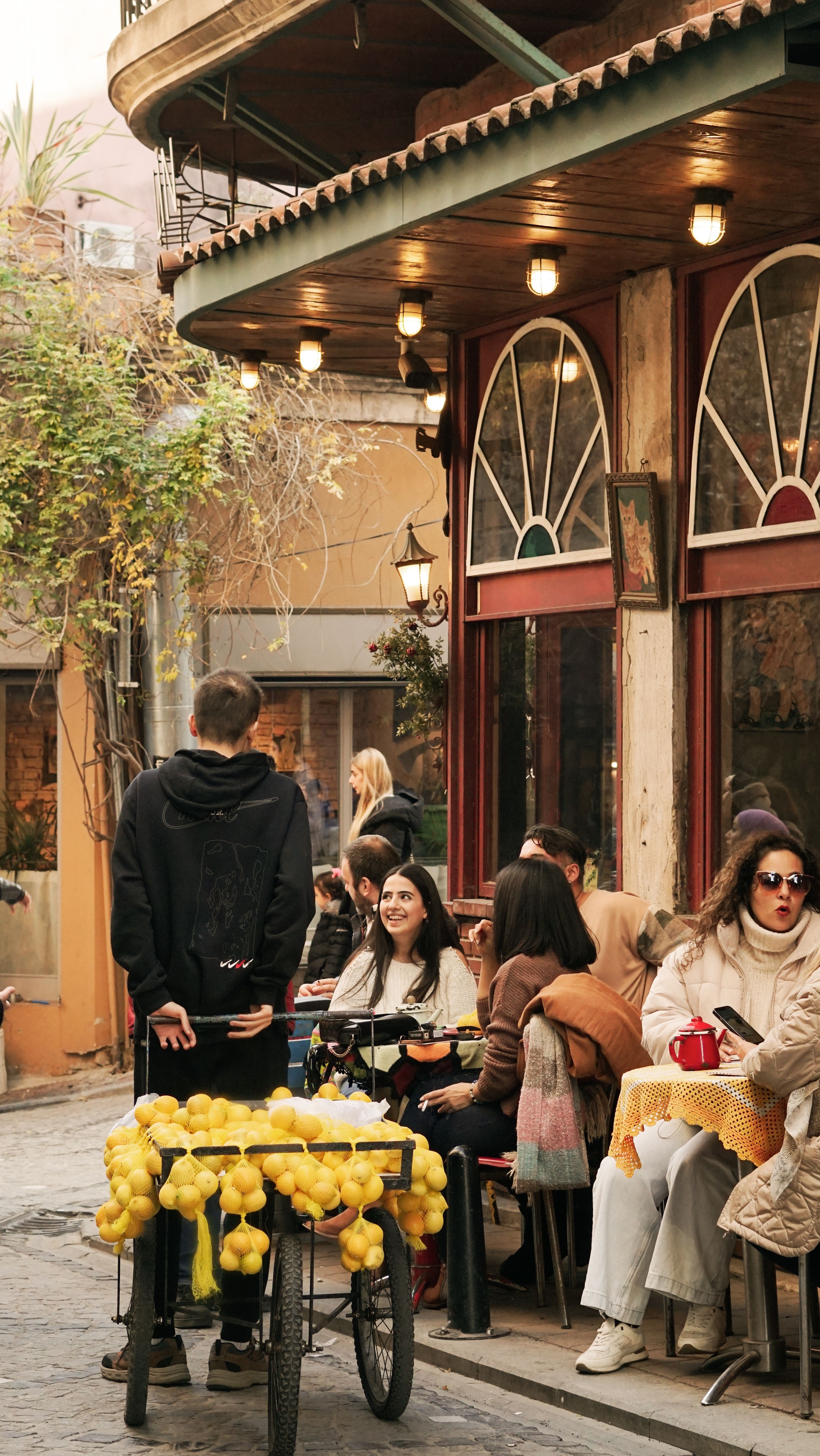 People sitting outside a cafe on a street · Free Stock Photo