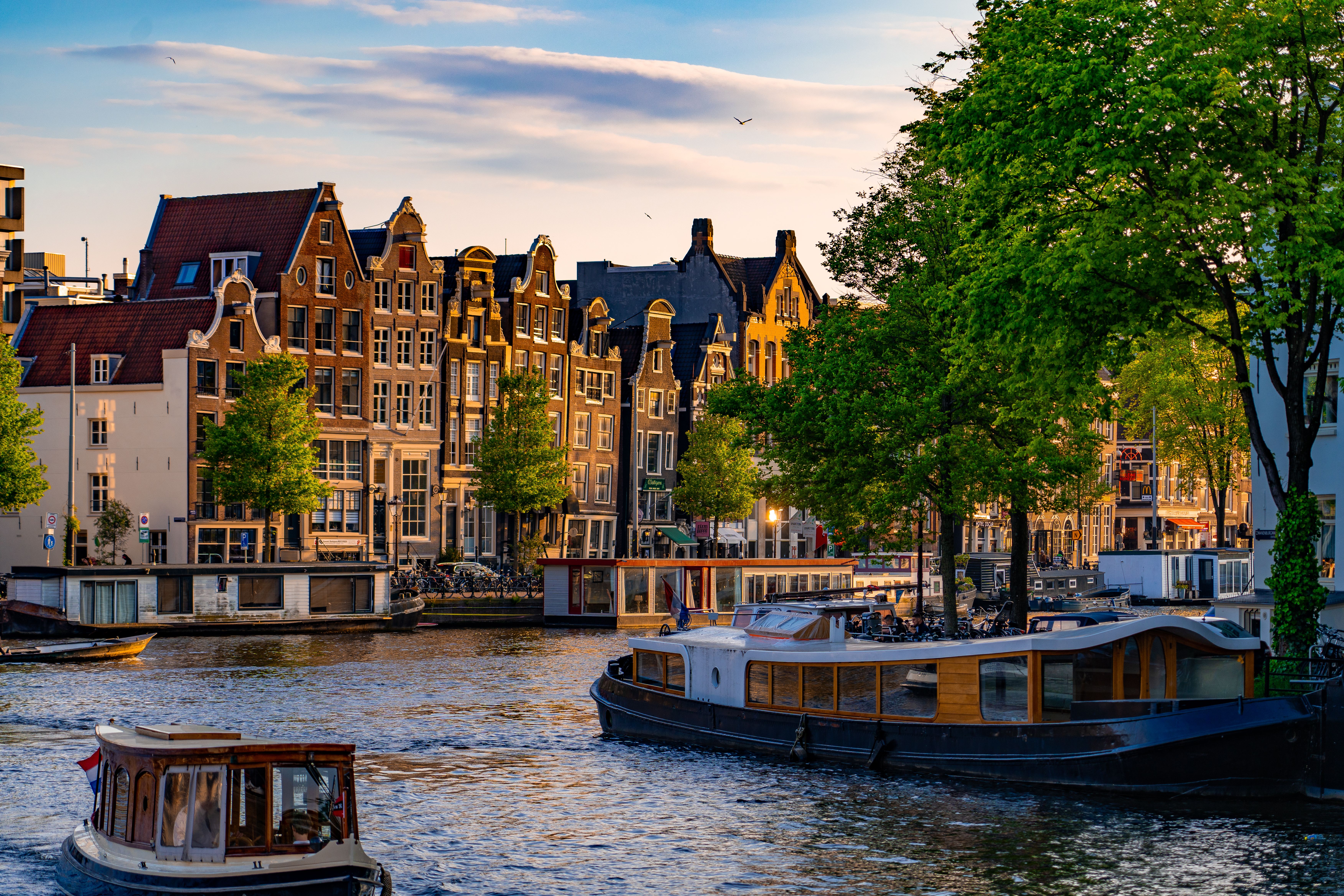 A boat on the water next to buildings · Free Stock Photo