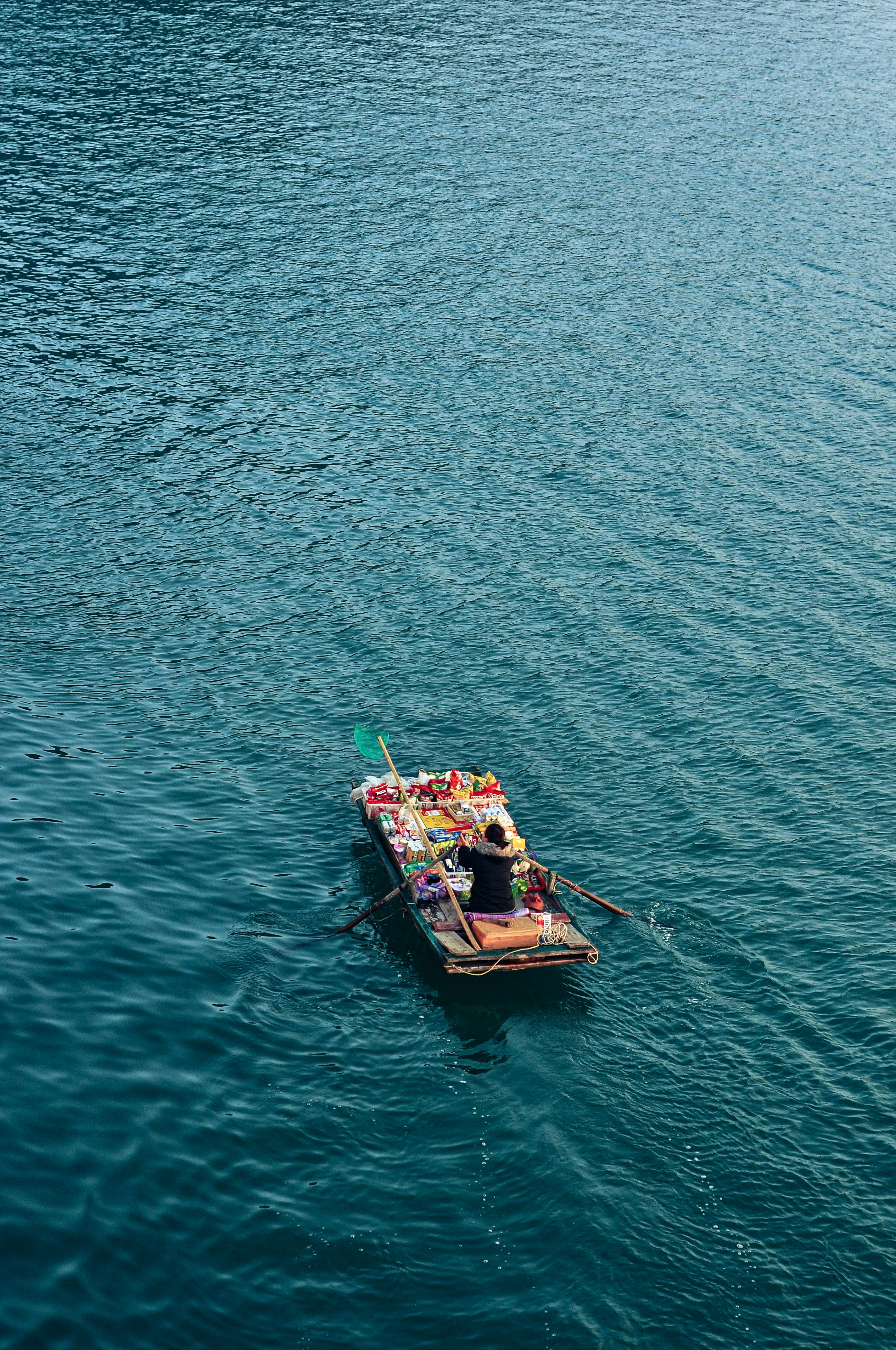 Man Swimming on a Raft by the Sea · Free Stock Photo