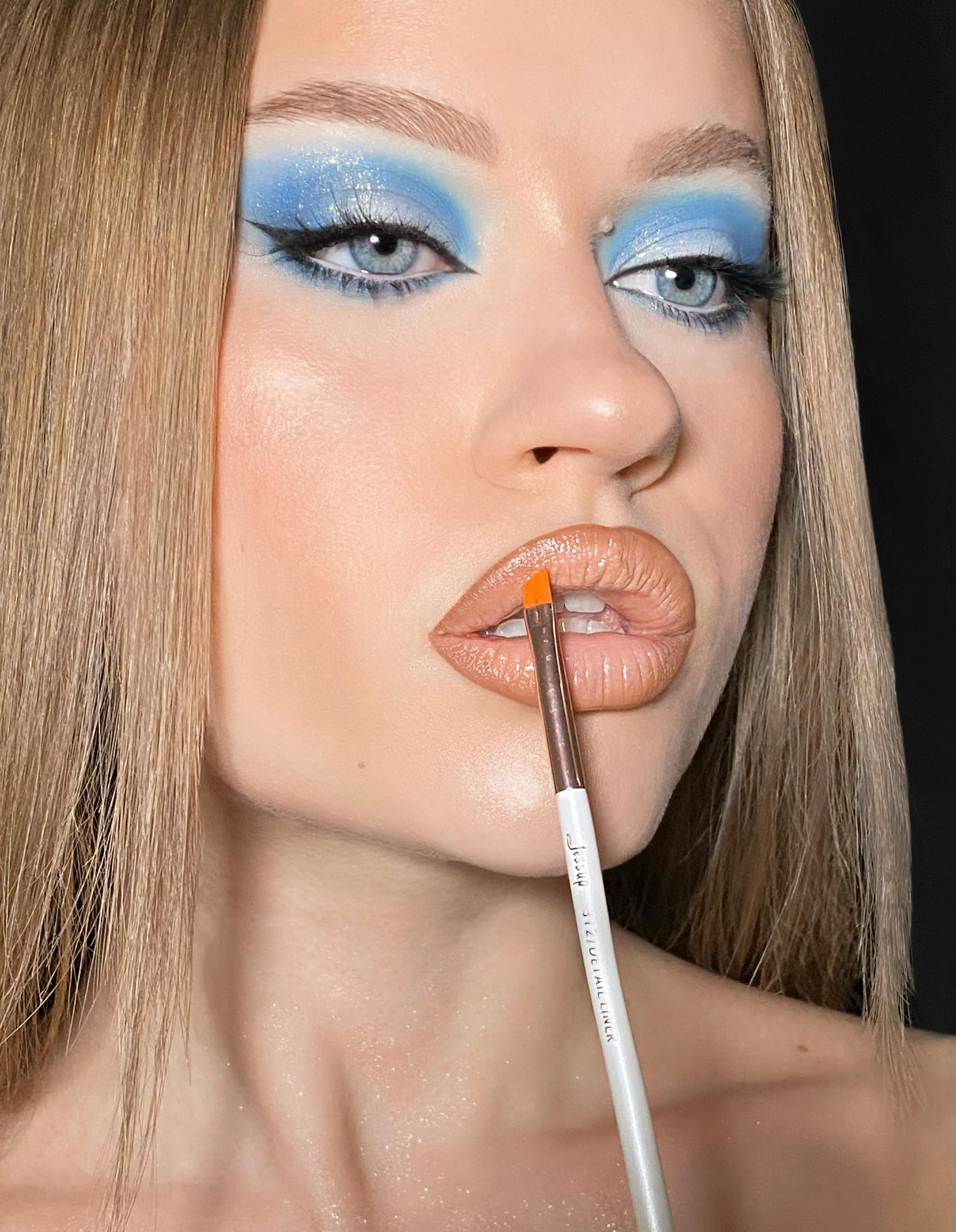 Model Posing in Glossy Makeup · Free Stock Photo