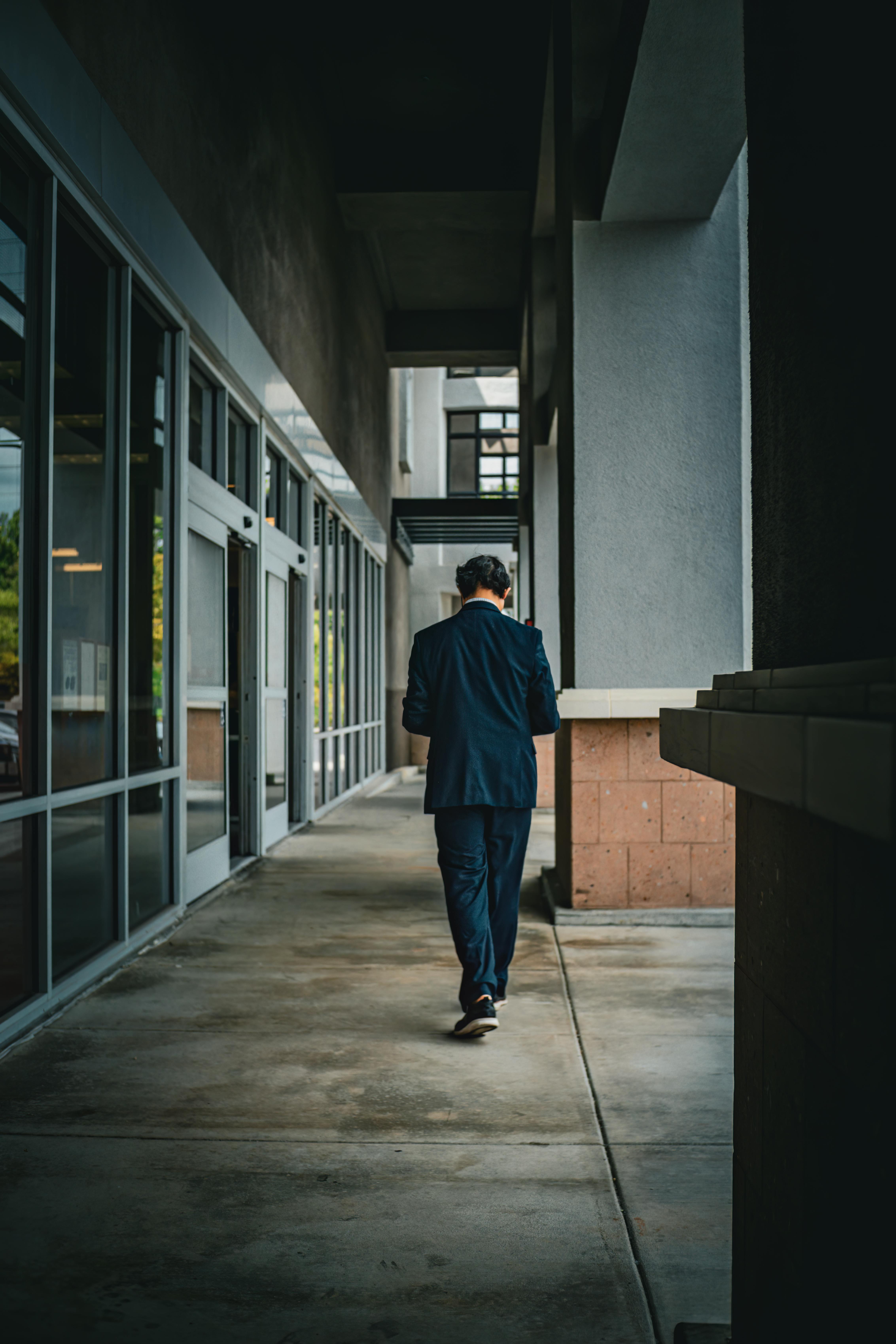 Man Walking Through Passage Between Rocks · Free Stock Photo