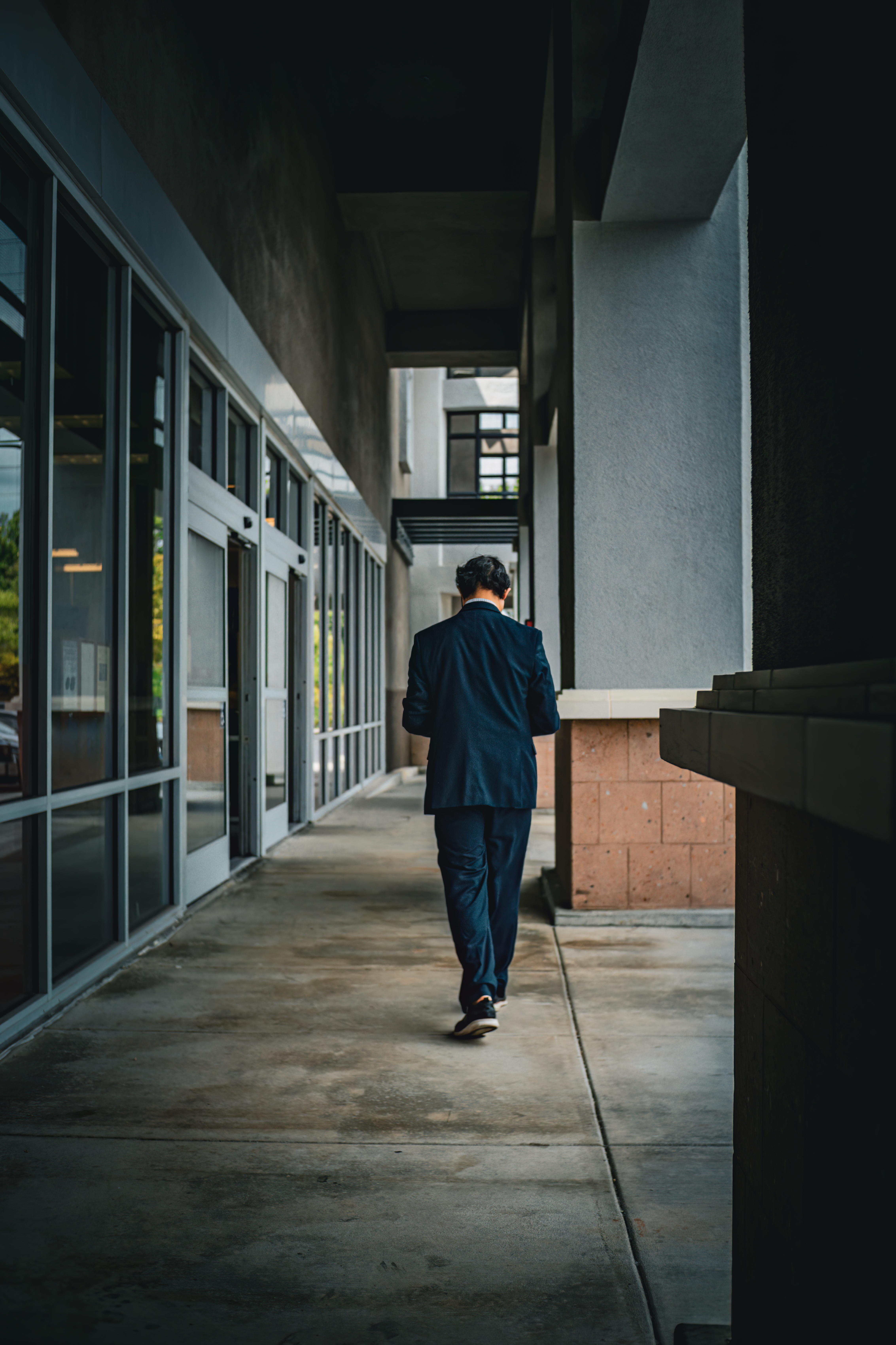 Back View of a Man Walking Through a Passage · Free Stock Photo