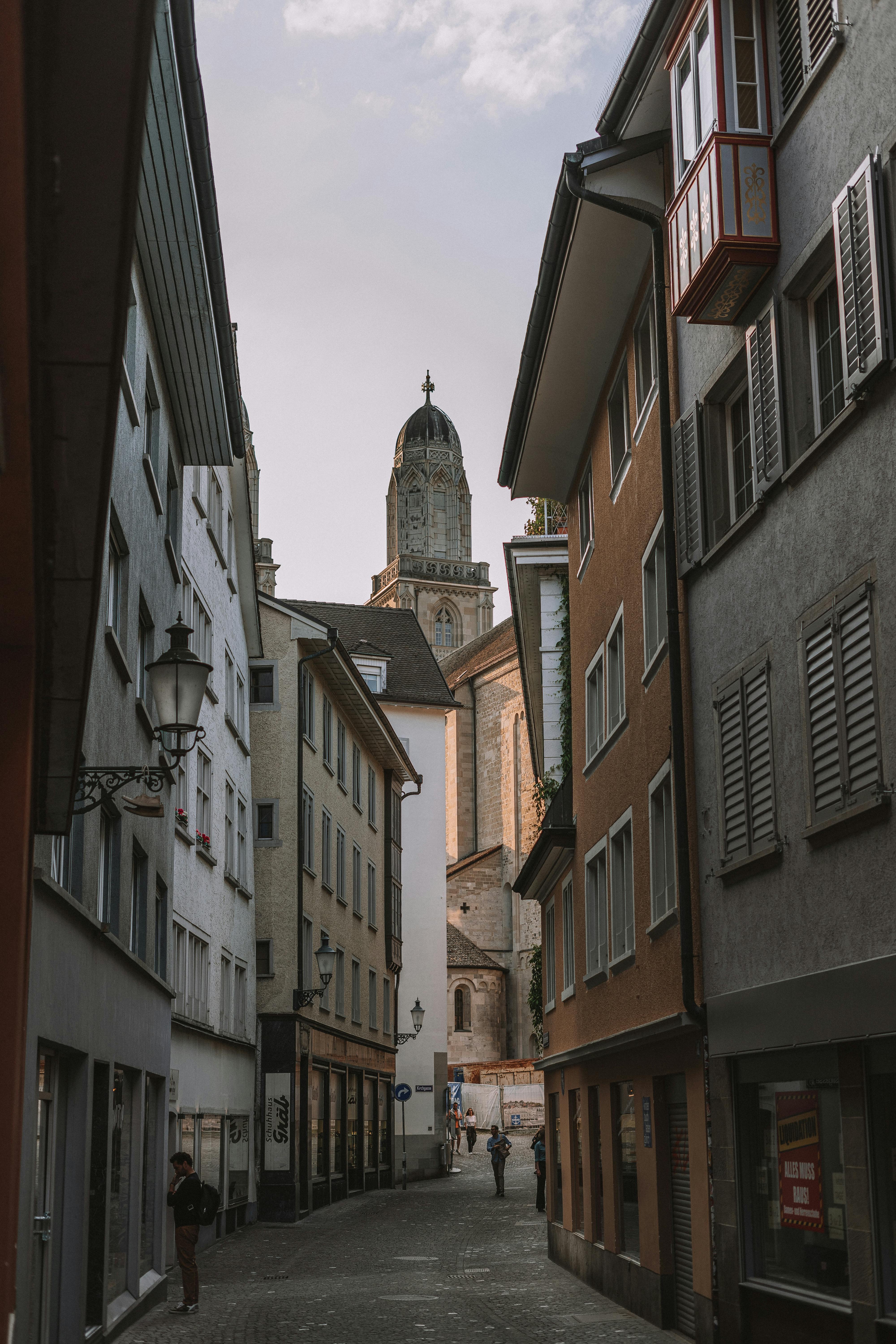 The Tower of the Grossmunster Cathedral seen from an Alley between ...