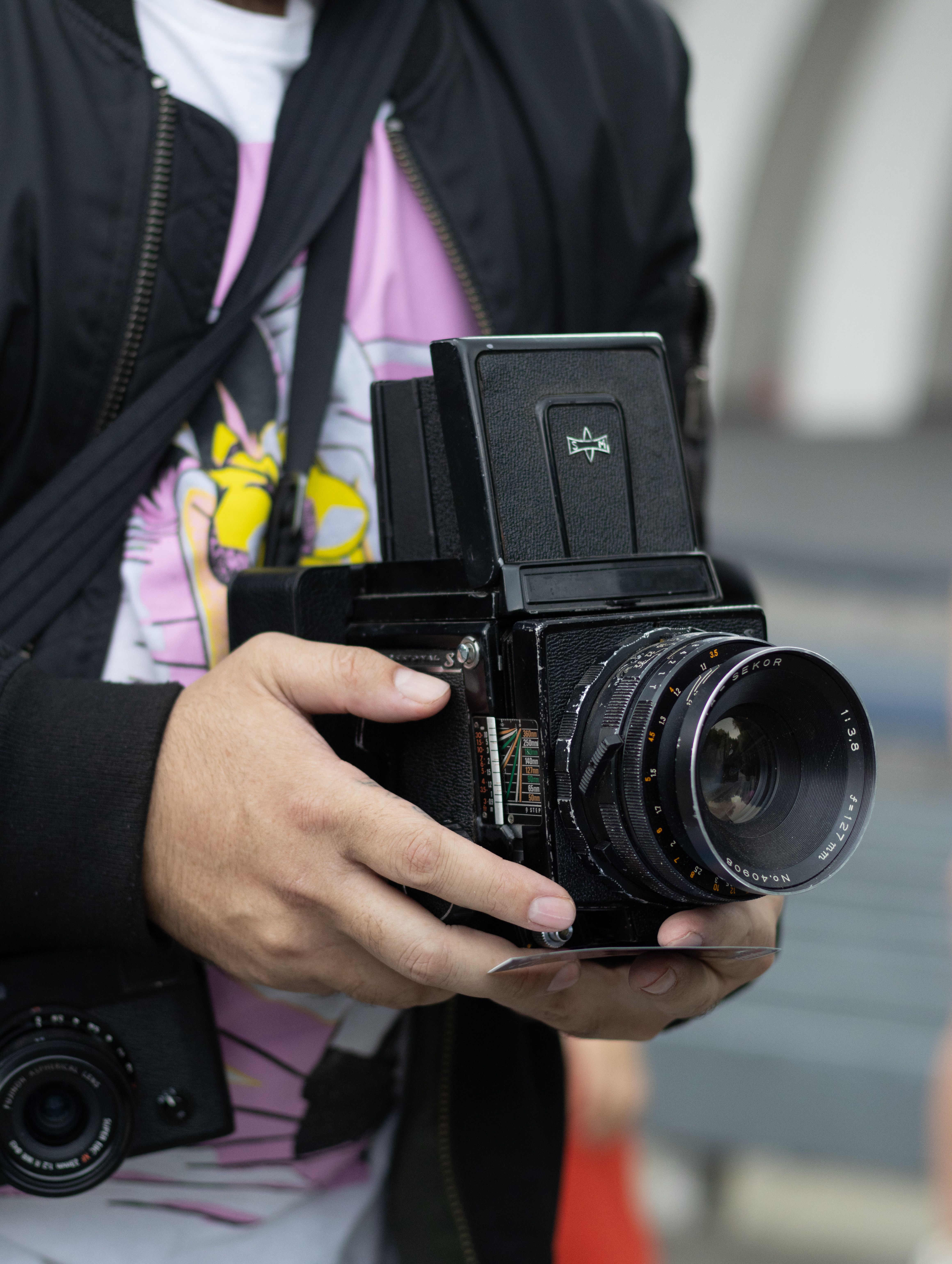 Person Wearing Coat and Old Fashioned Camera on City Street · Free ...