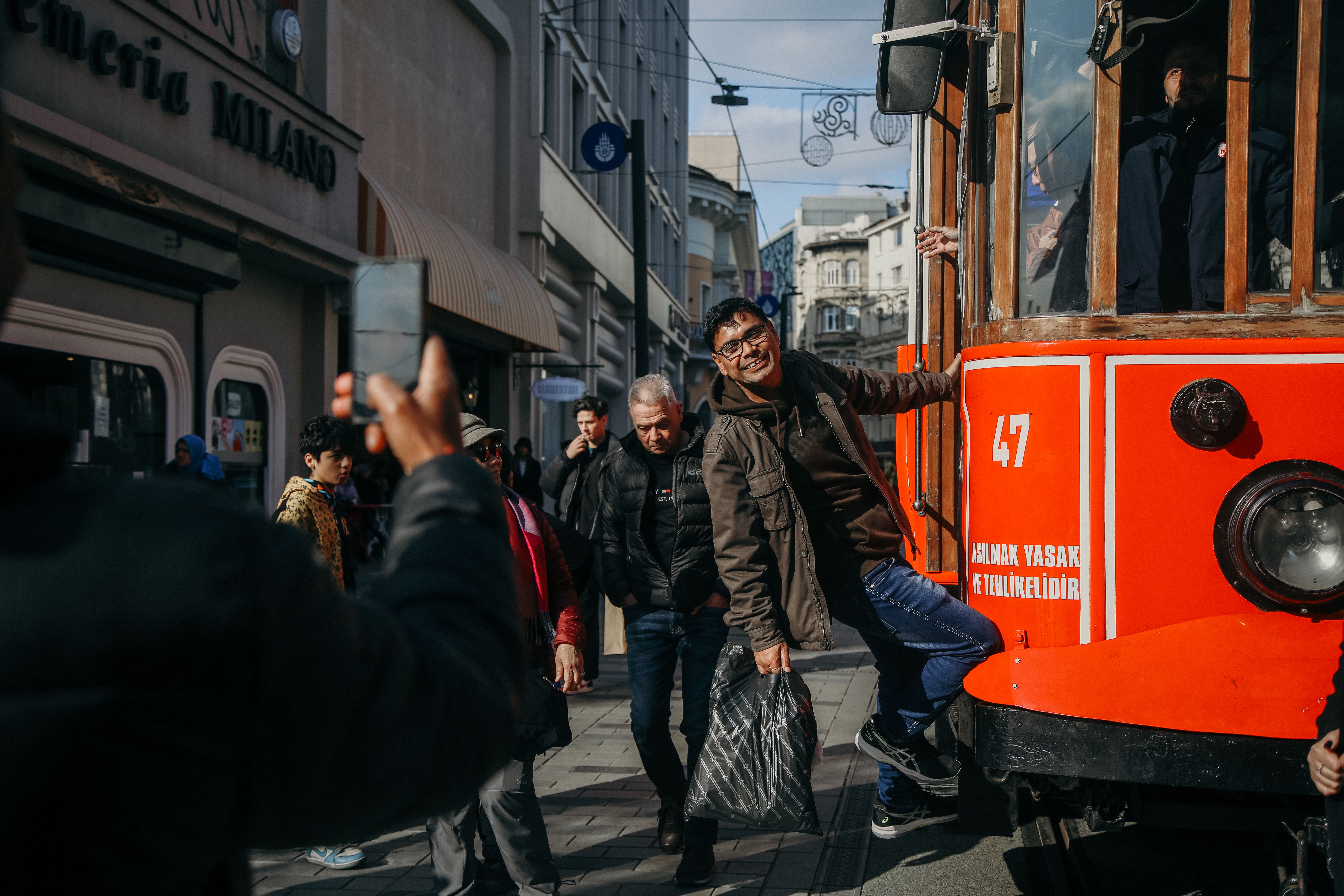 Smiling Man Getting Into a Historic Tram Photographed by a Friend ...