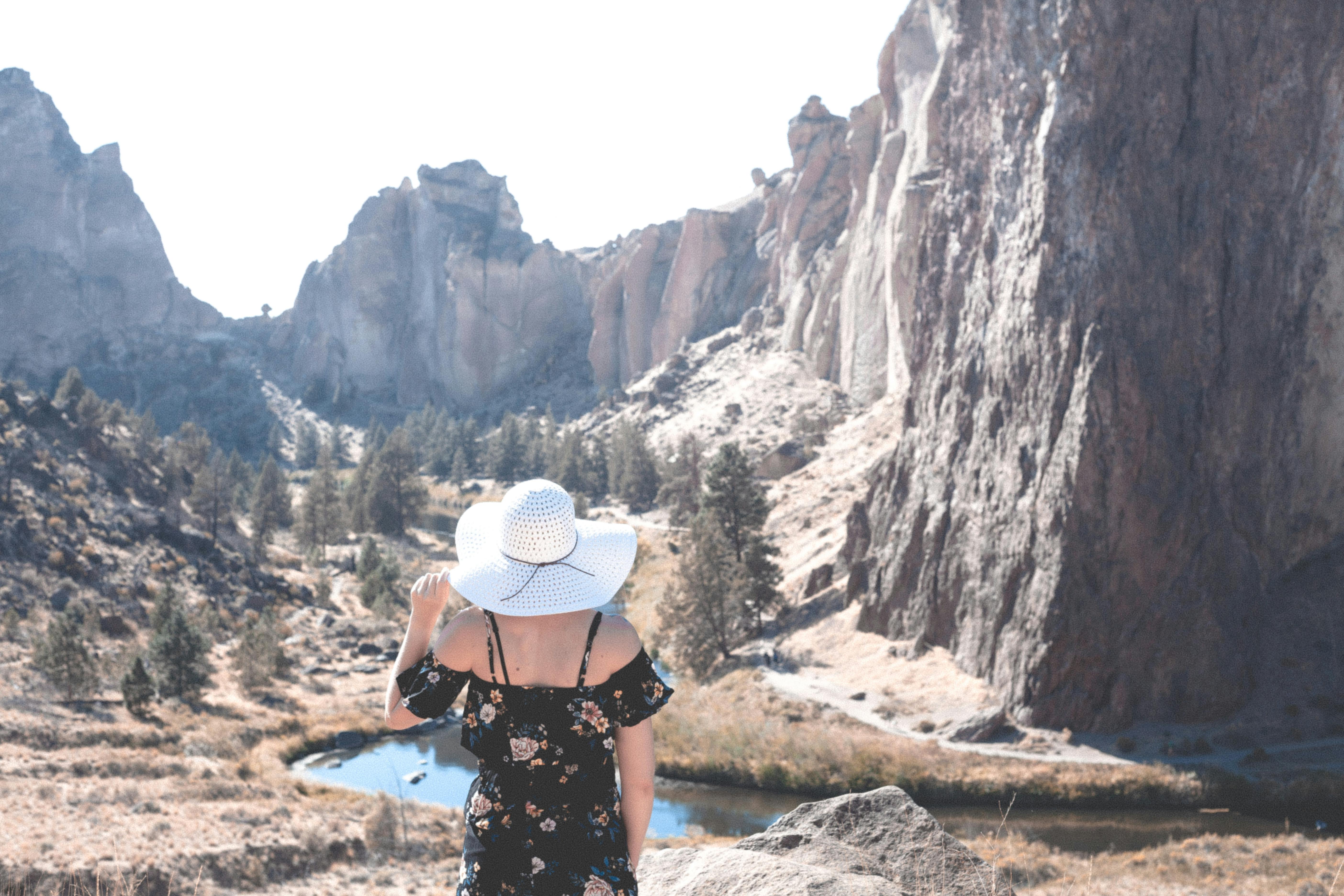 Back View Photo of Women in Black Floral Dress and White Sun Hat ...
