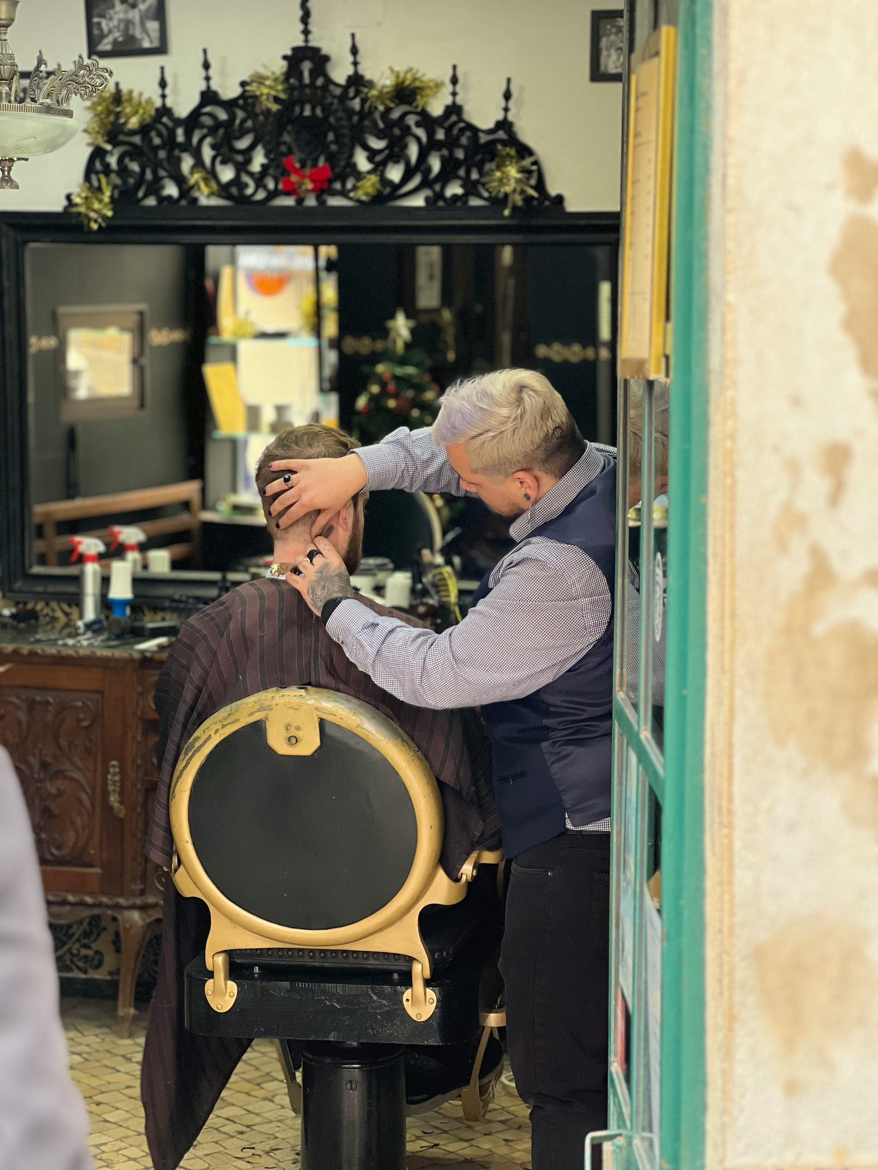 Elderly Barber Cutting Client Hair · Free Stock Photo