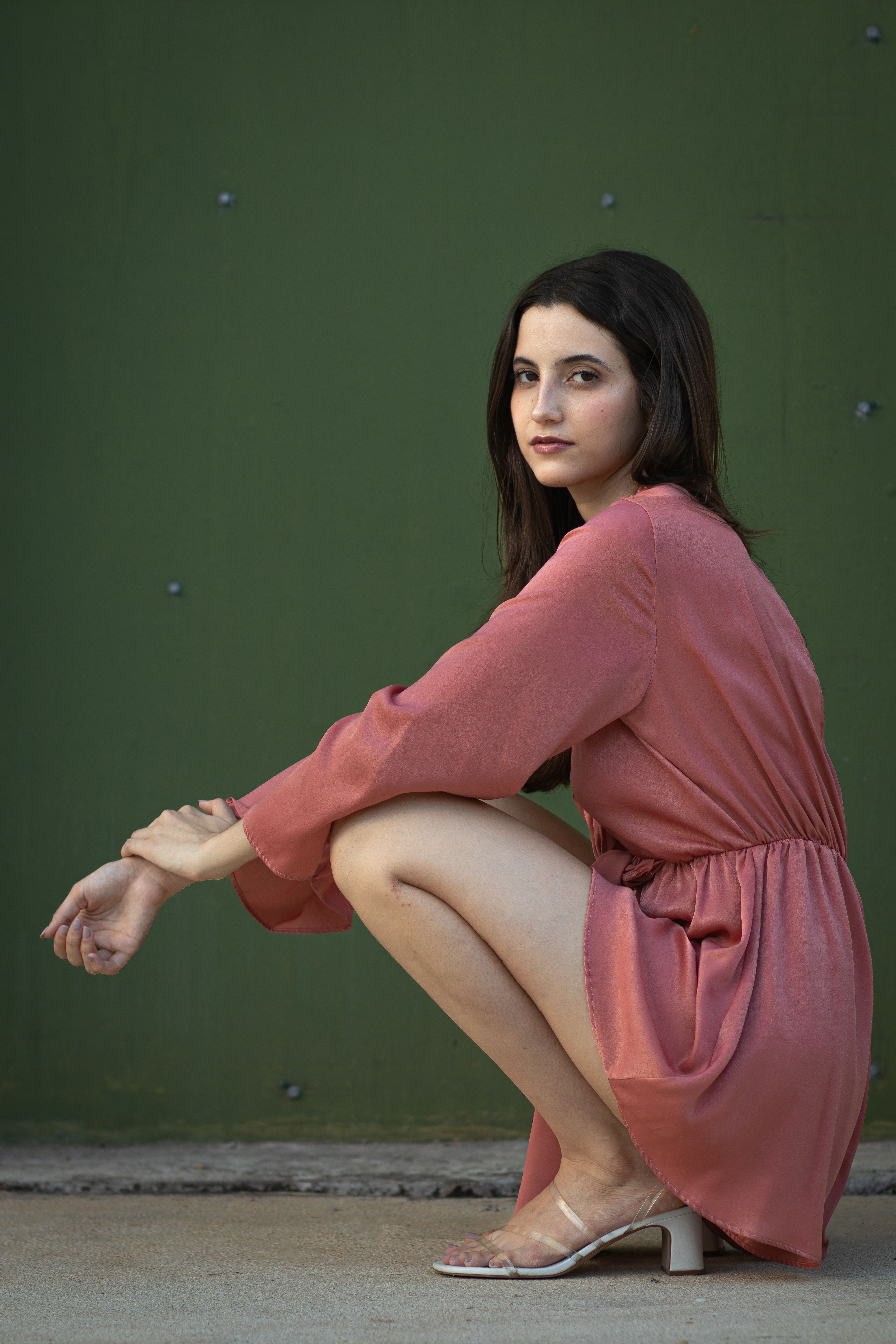 Woman in Pale Loose Dress Crouching on Street · Free Stock Photo