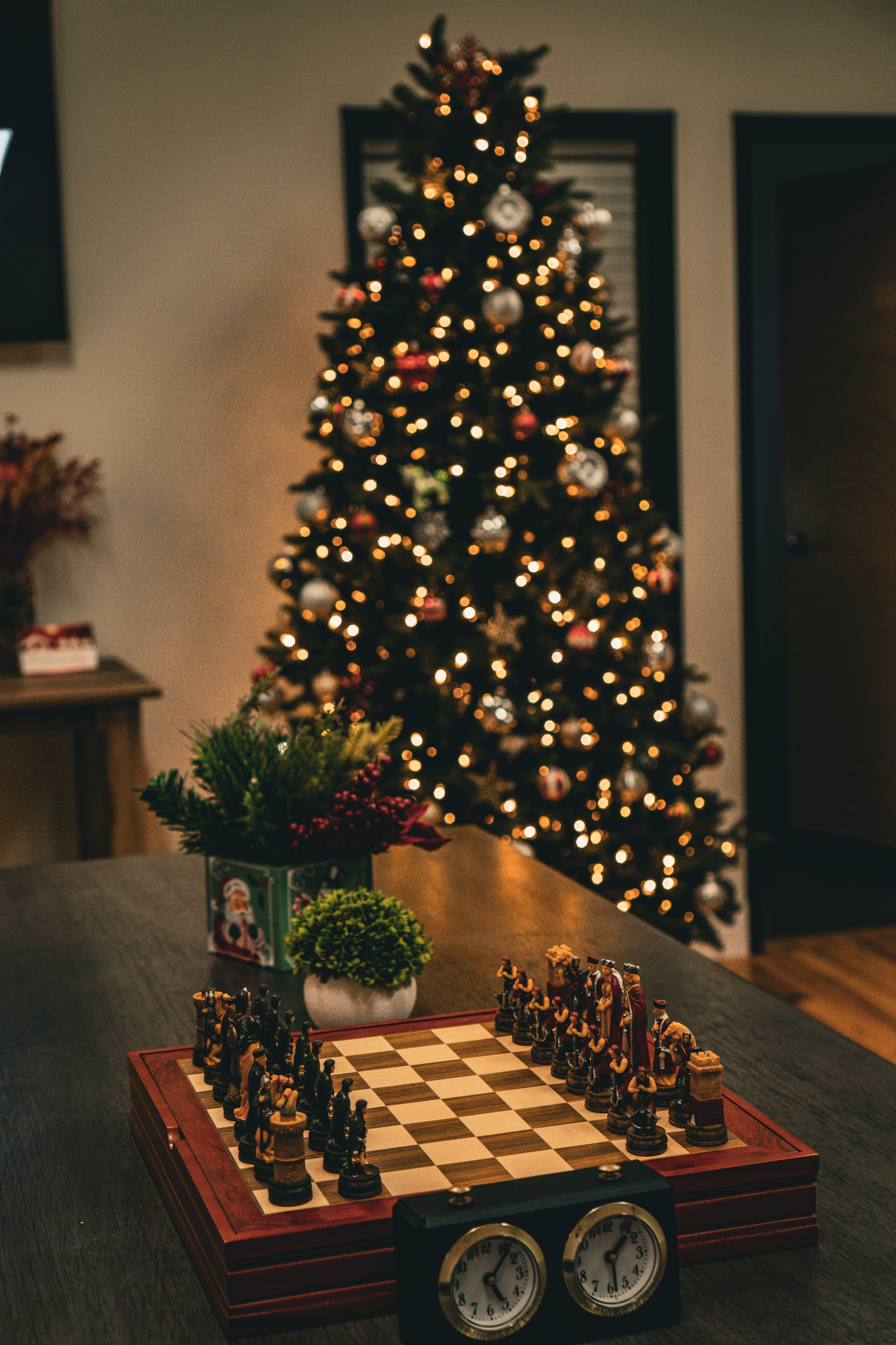 Chess on Table and Christmas Tree behind · Free Stock Photo
