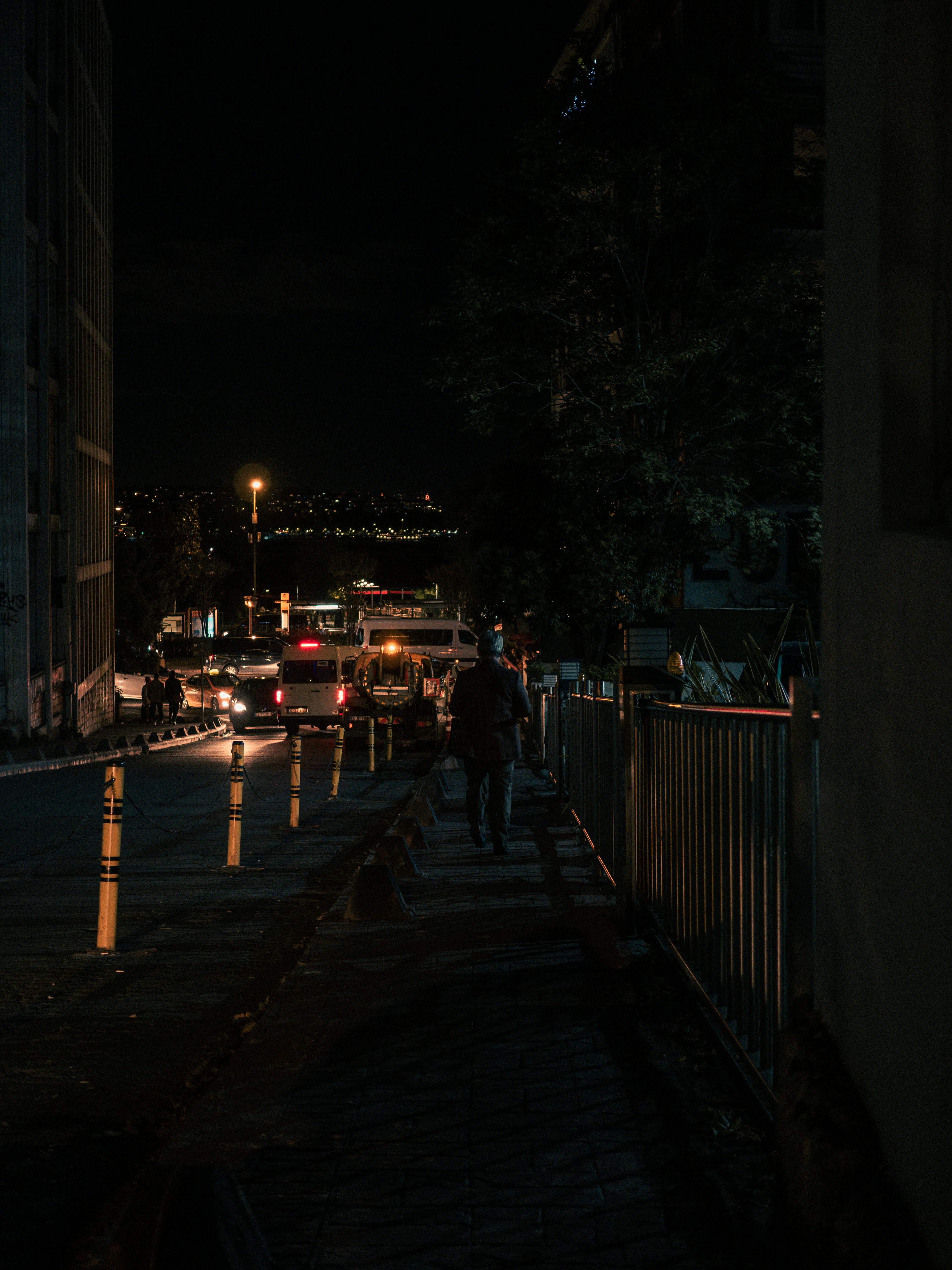 Passerby on the Sidewalk at Night · Free Stock Photo