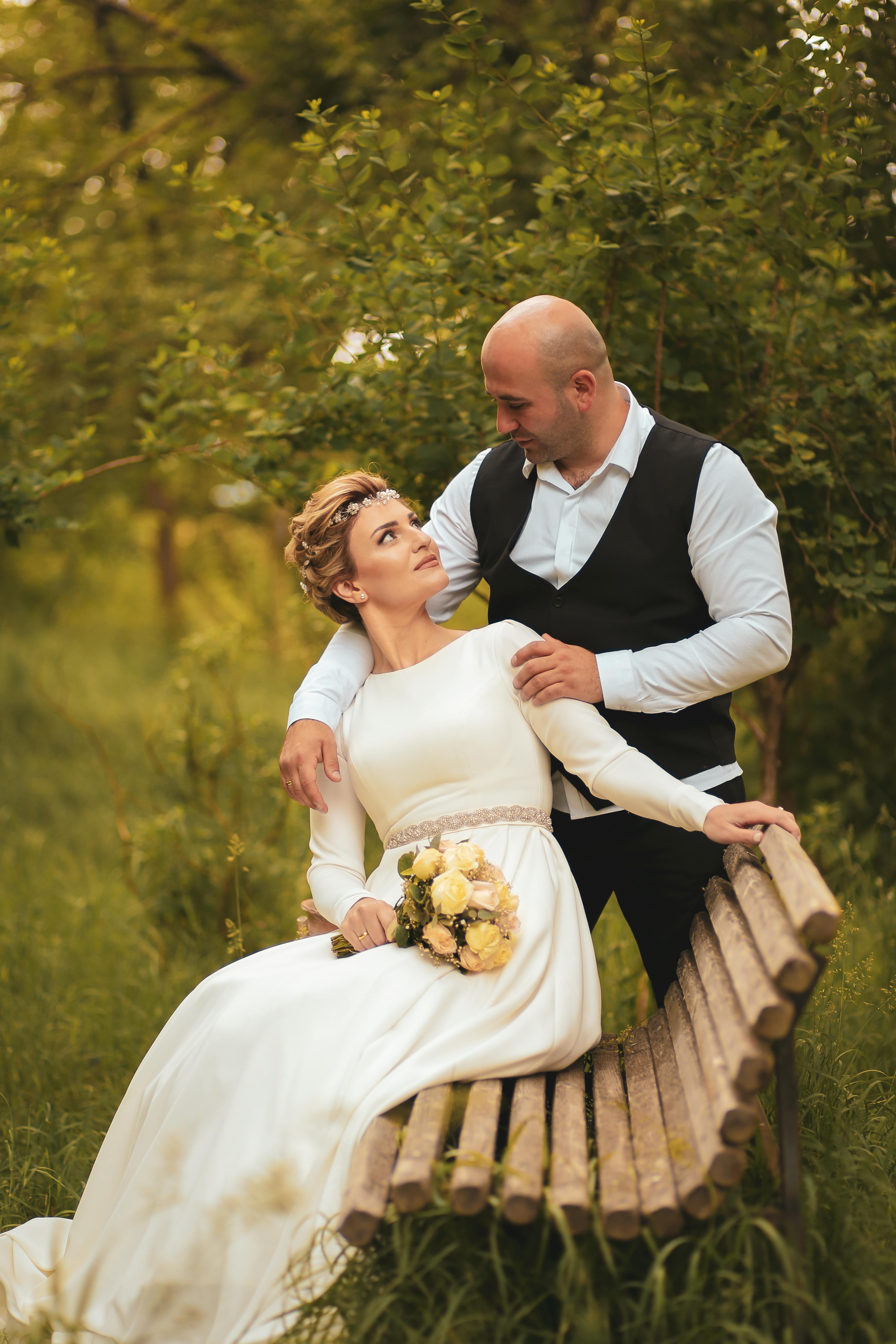 Man Carrying Woman in Wedding Dress · Free Stock Photo