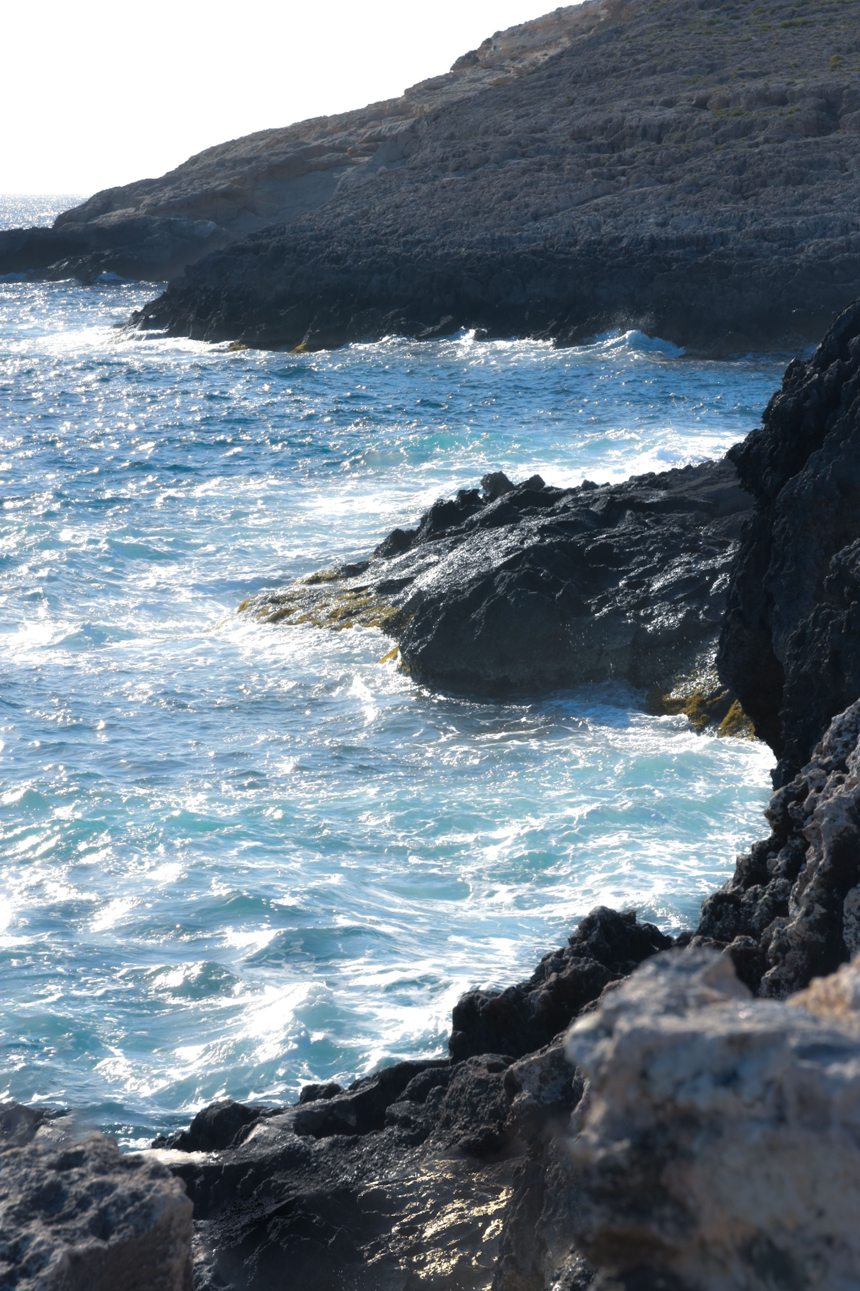 Blue Ocean Water Washing the Black Rocks of the Coast · Free Stock Photo
