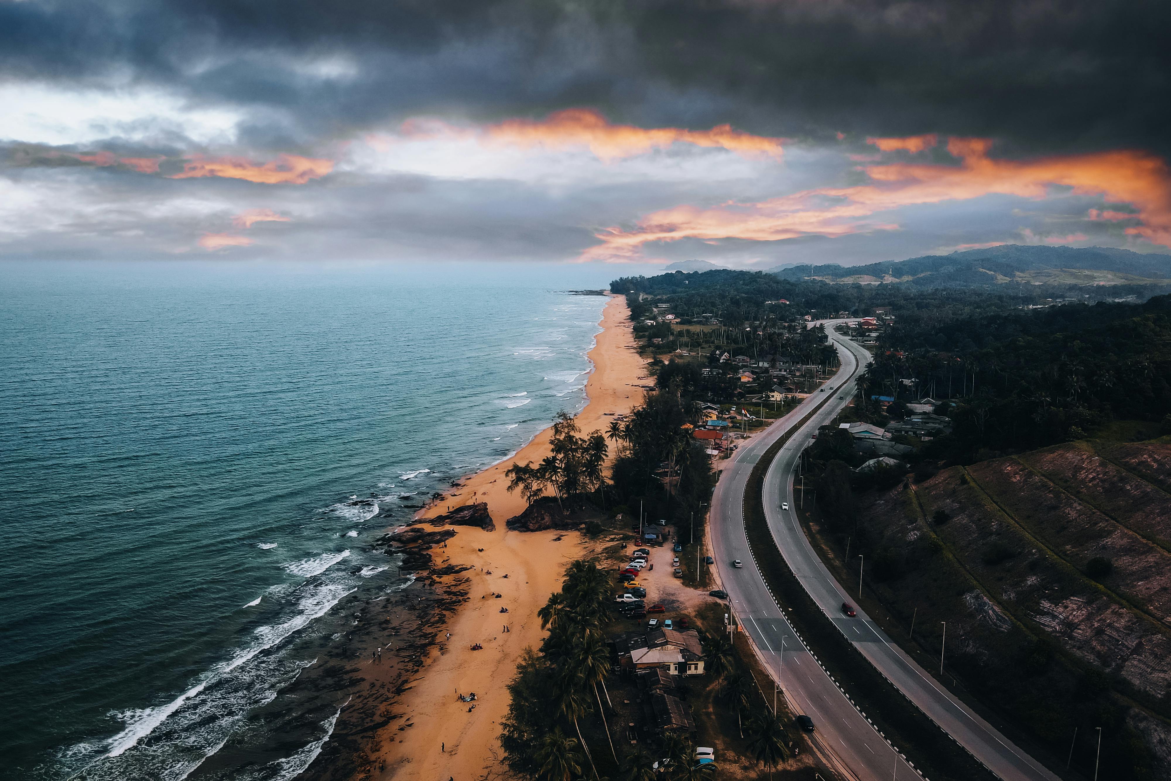 Overcast over Sea Shore with Beach and Road · Free Stock Photo