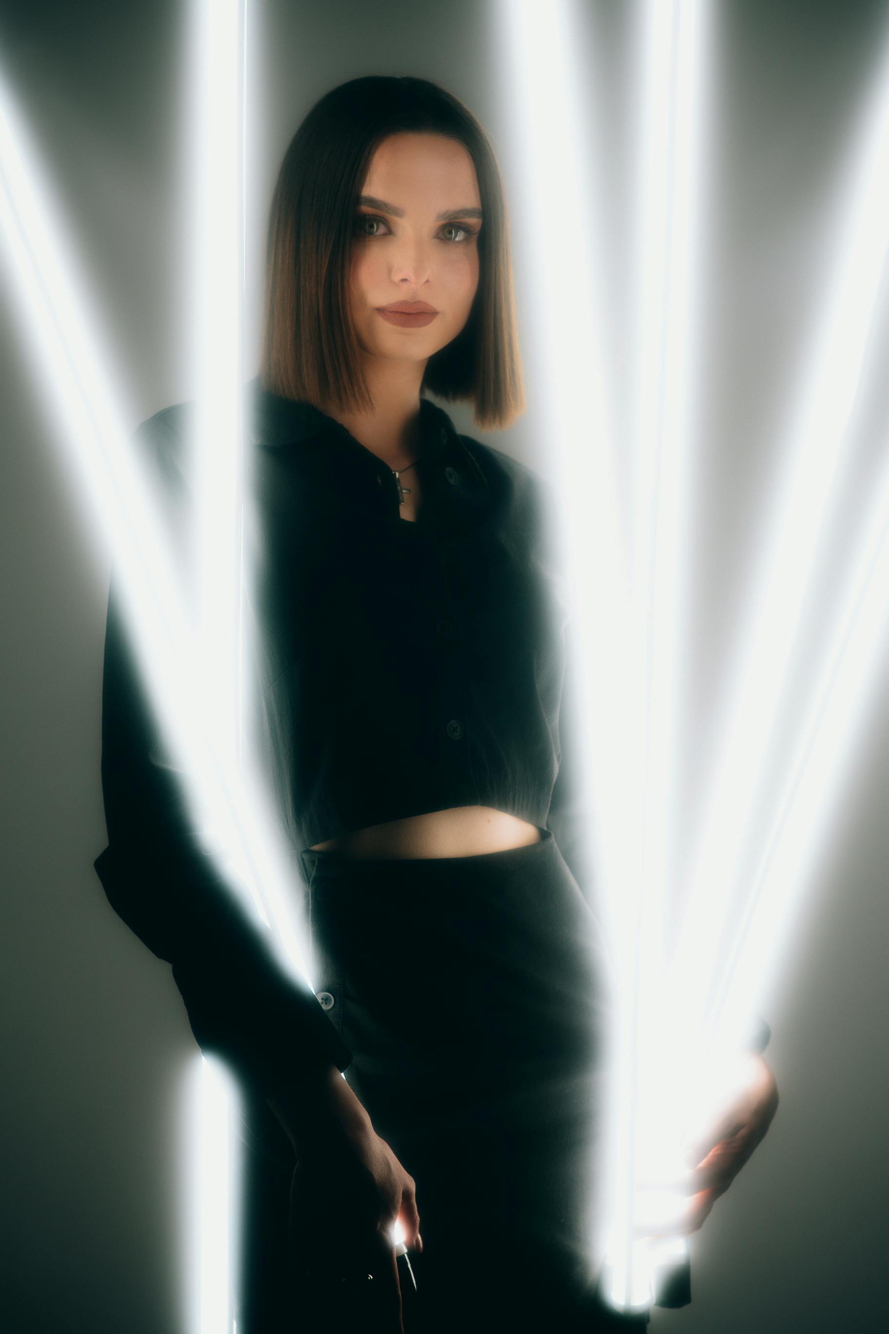 Lights over Woman Posing in Black Clothes · Free Stock Photo