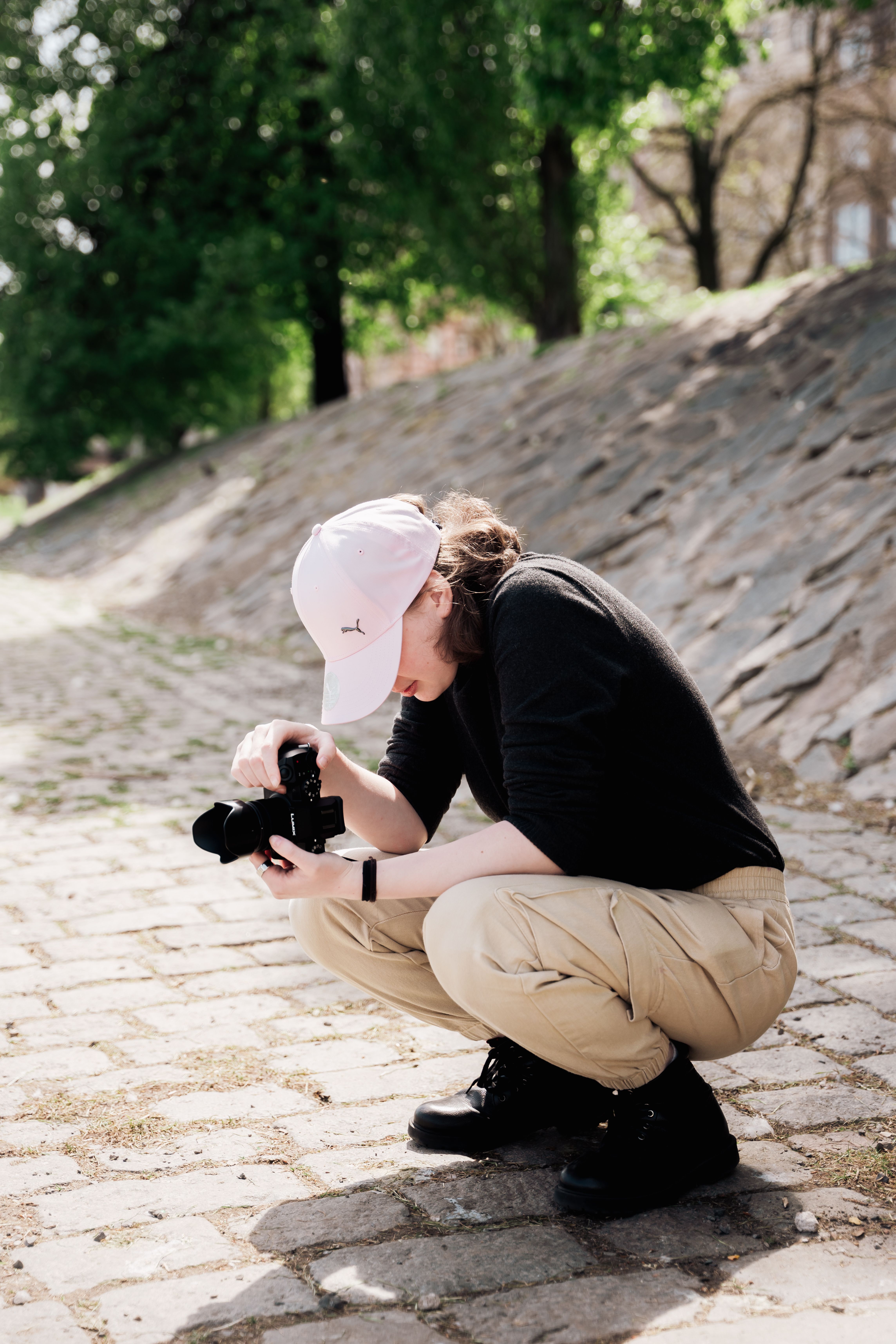 Squatting Woman Taking a Photo · Free Stock Photo