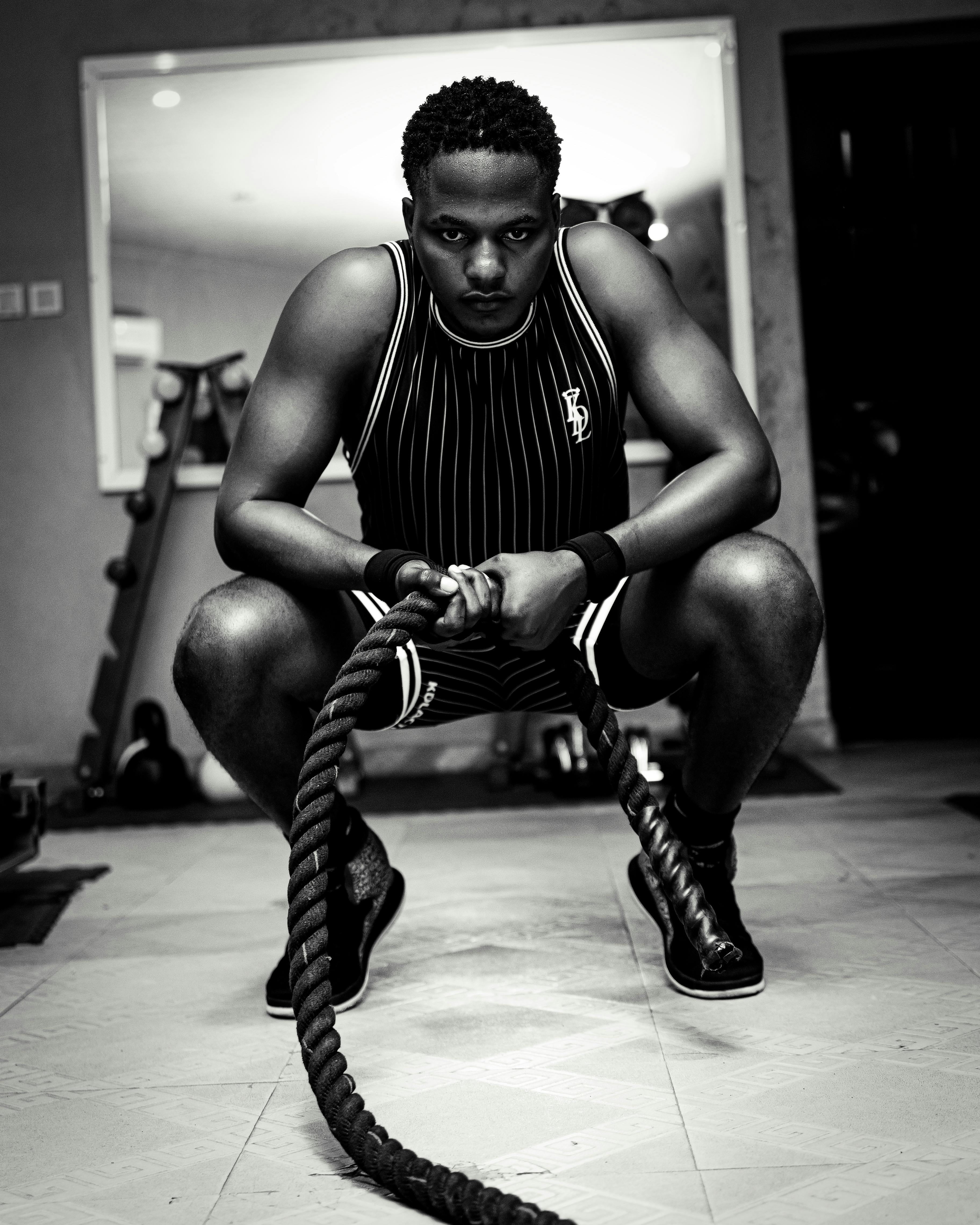 Man Squatting and Posing with Rope at Gym · Free Stock Photo