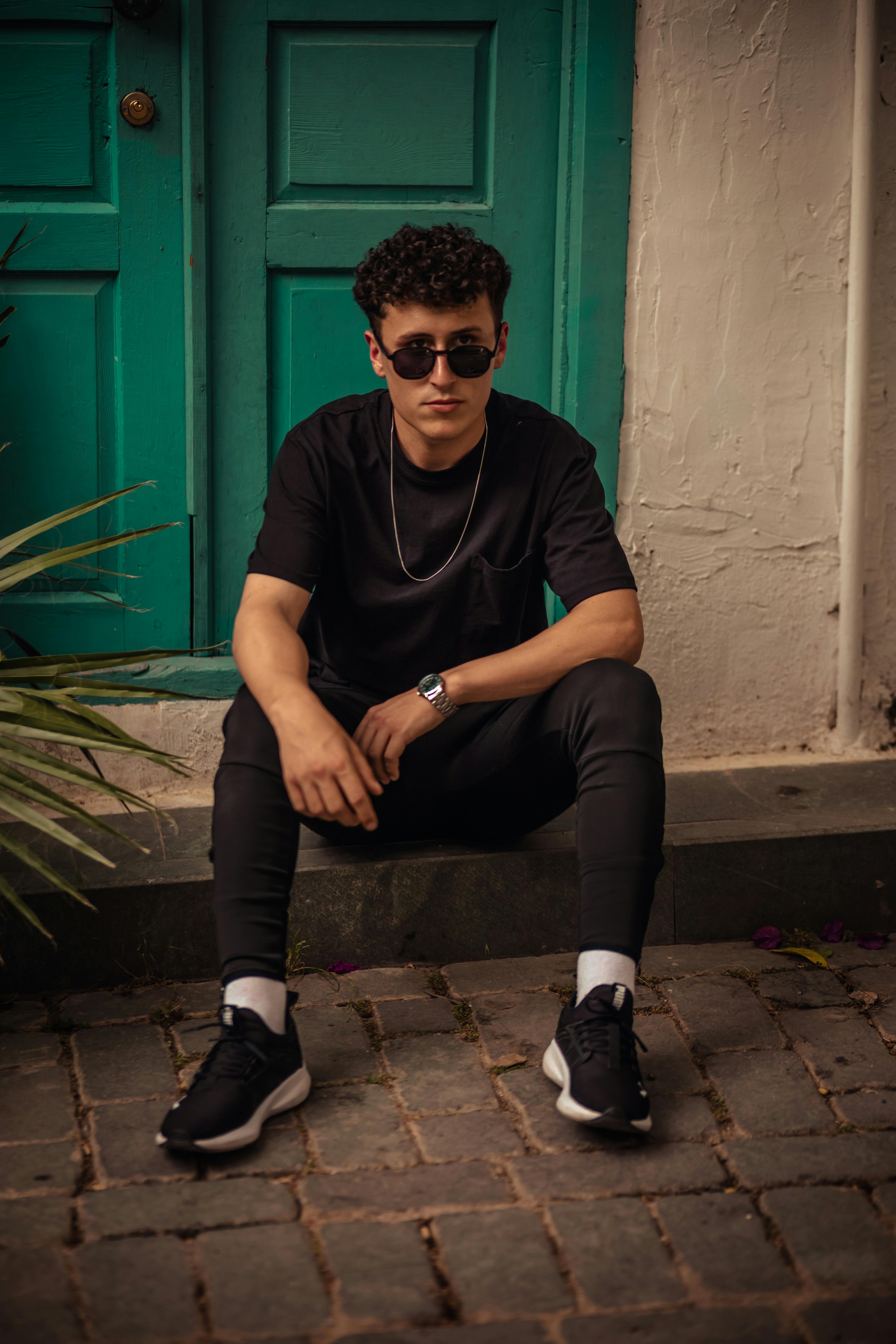 Man Sitting on Step by House Entrance · Free Stock Photo