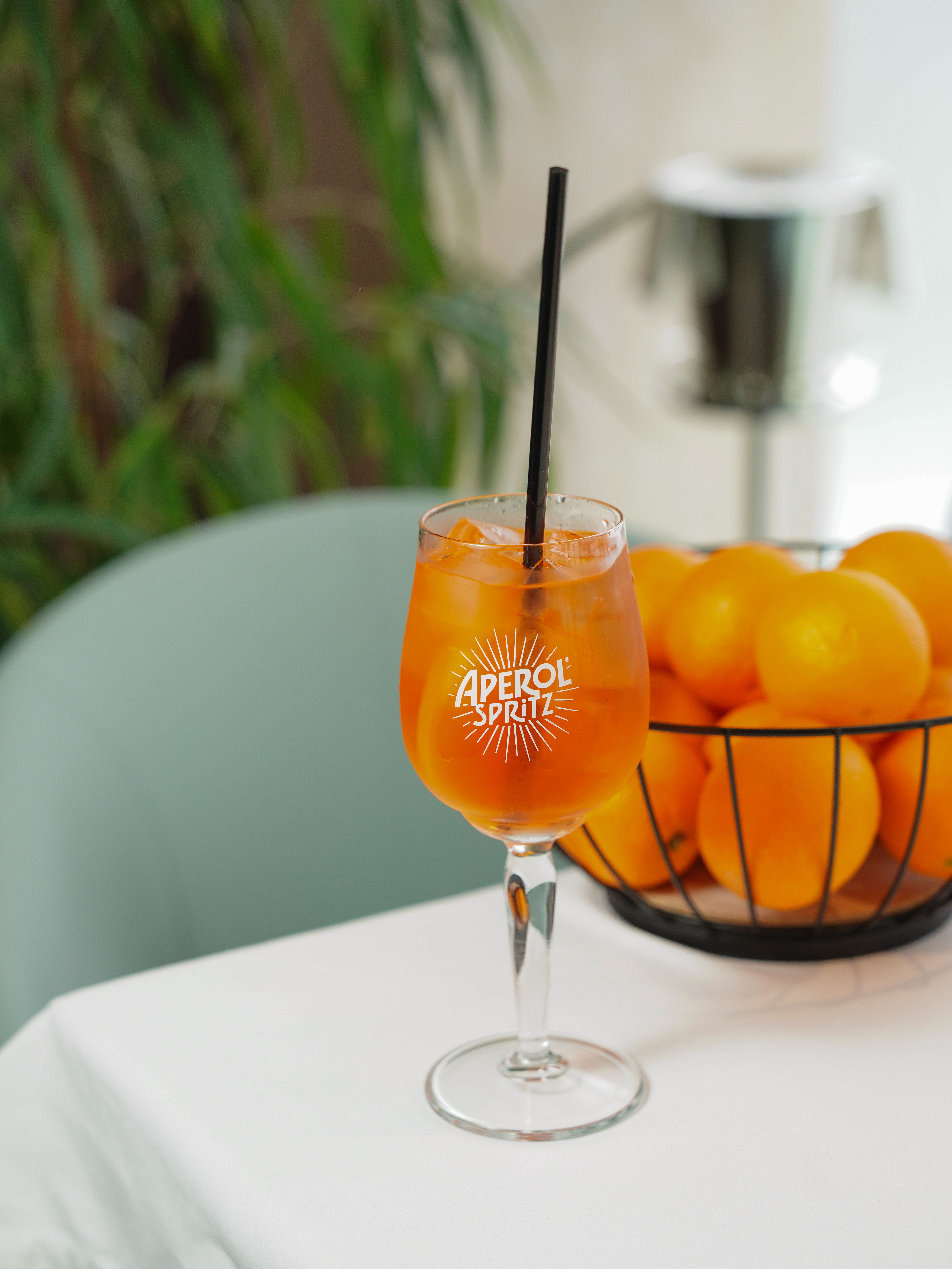 Aperol Spritz and Bowl with Oranges on Table · Free Stock Photo
