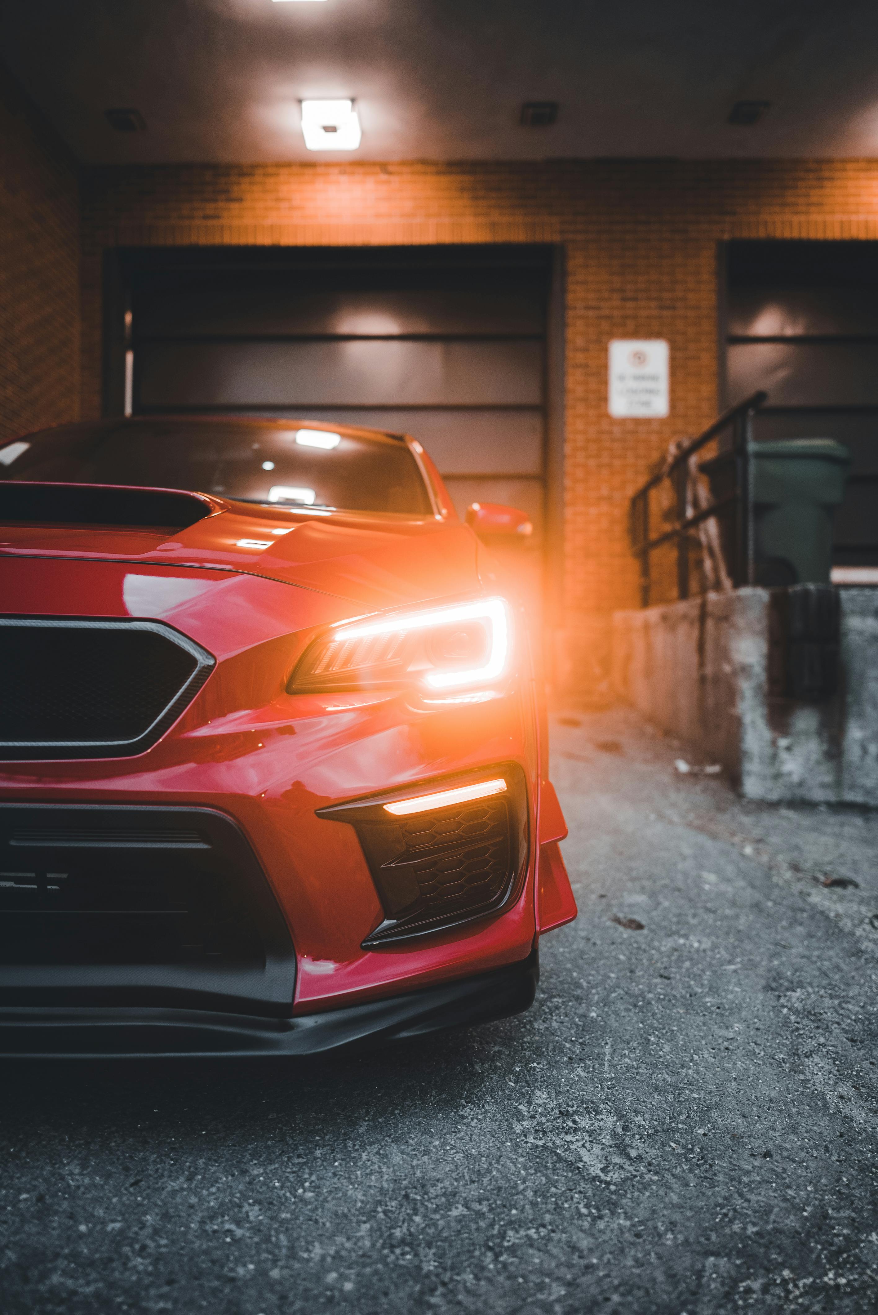 A Red Subaru WRX with Headlights on · Free Stock Photo