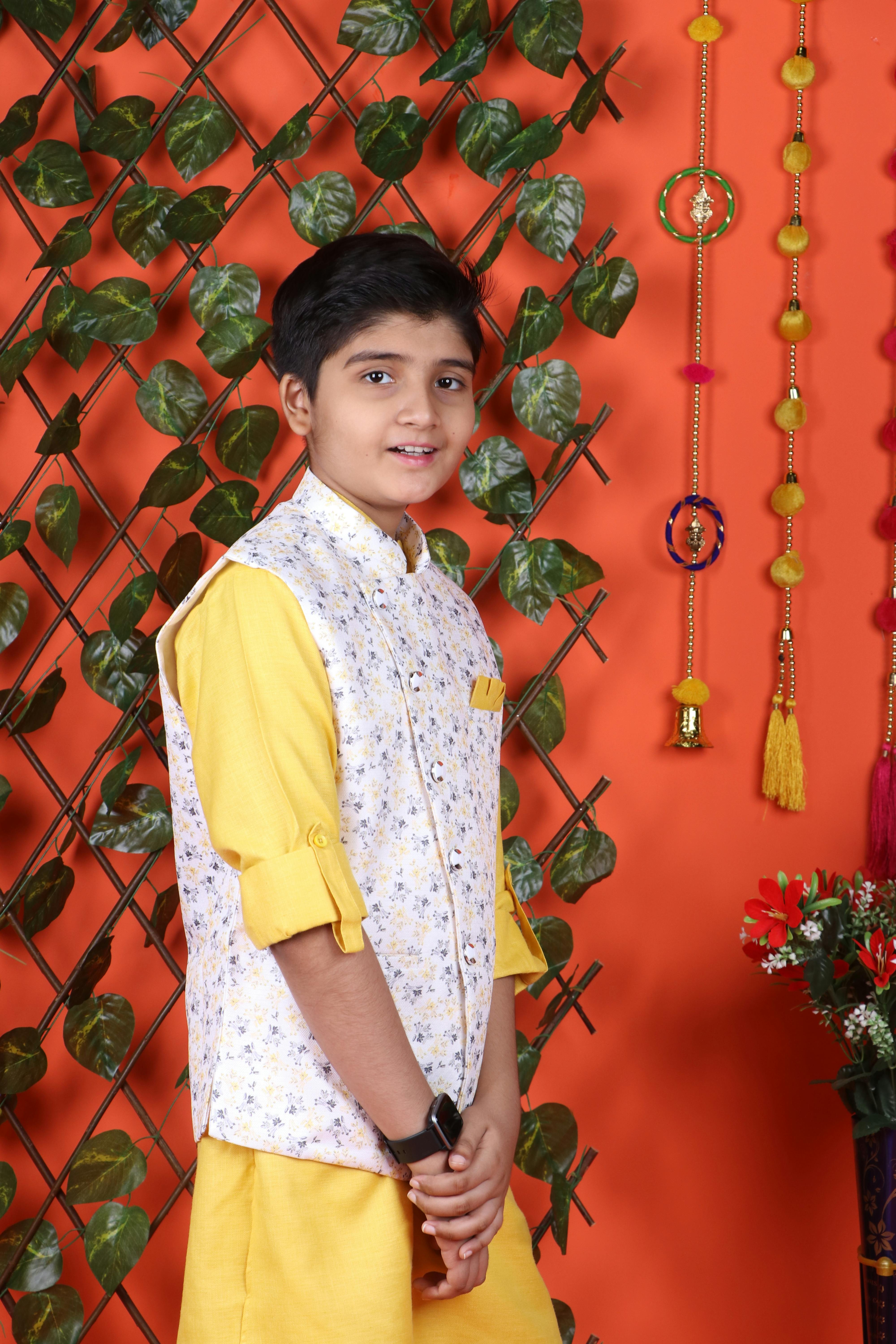 A Young Boy in a Traditional Outfit Posing in Studio · Free Stock Photo