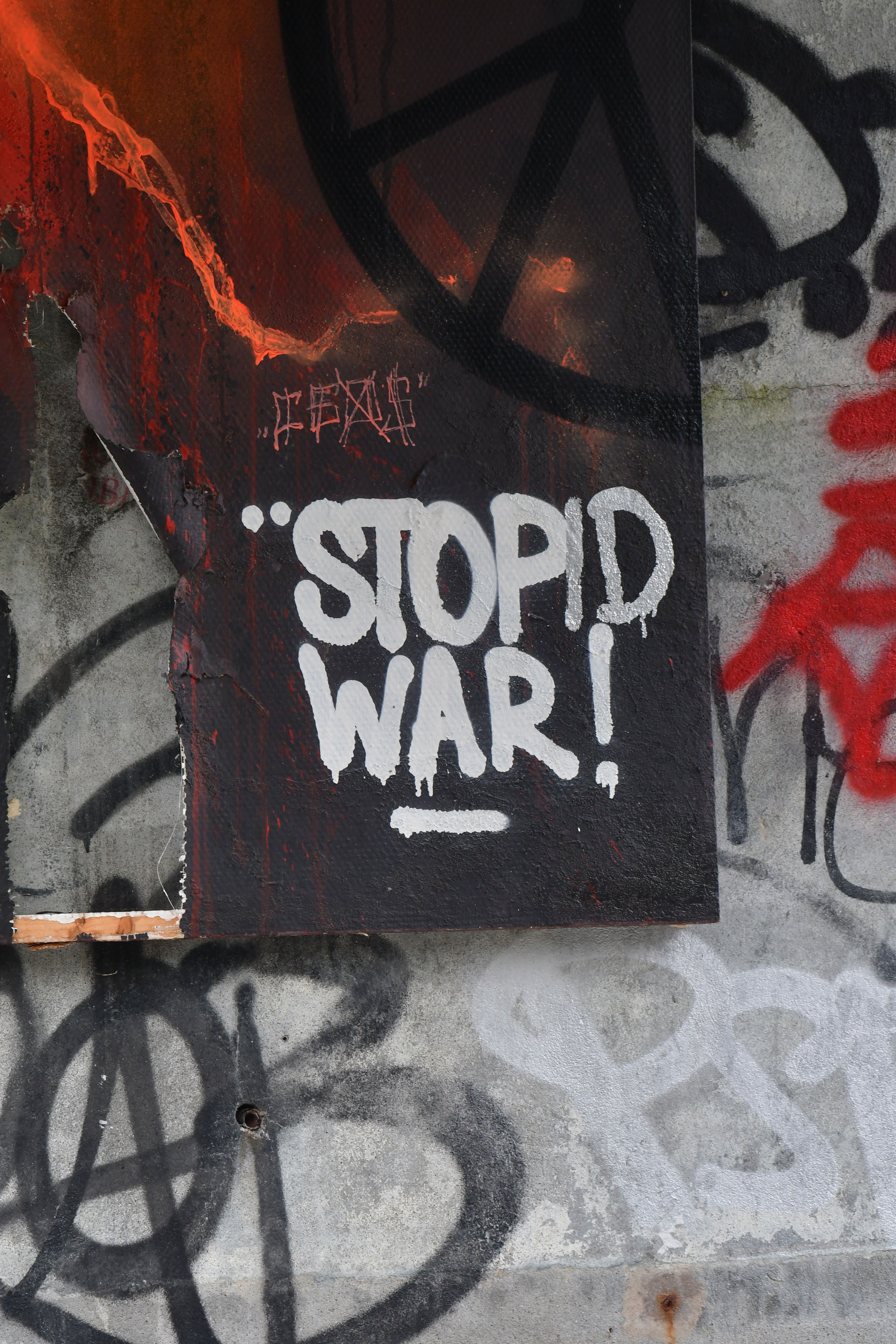Graffiti and a Sign Stop War on the Wall · Free Stock Photo