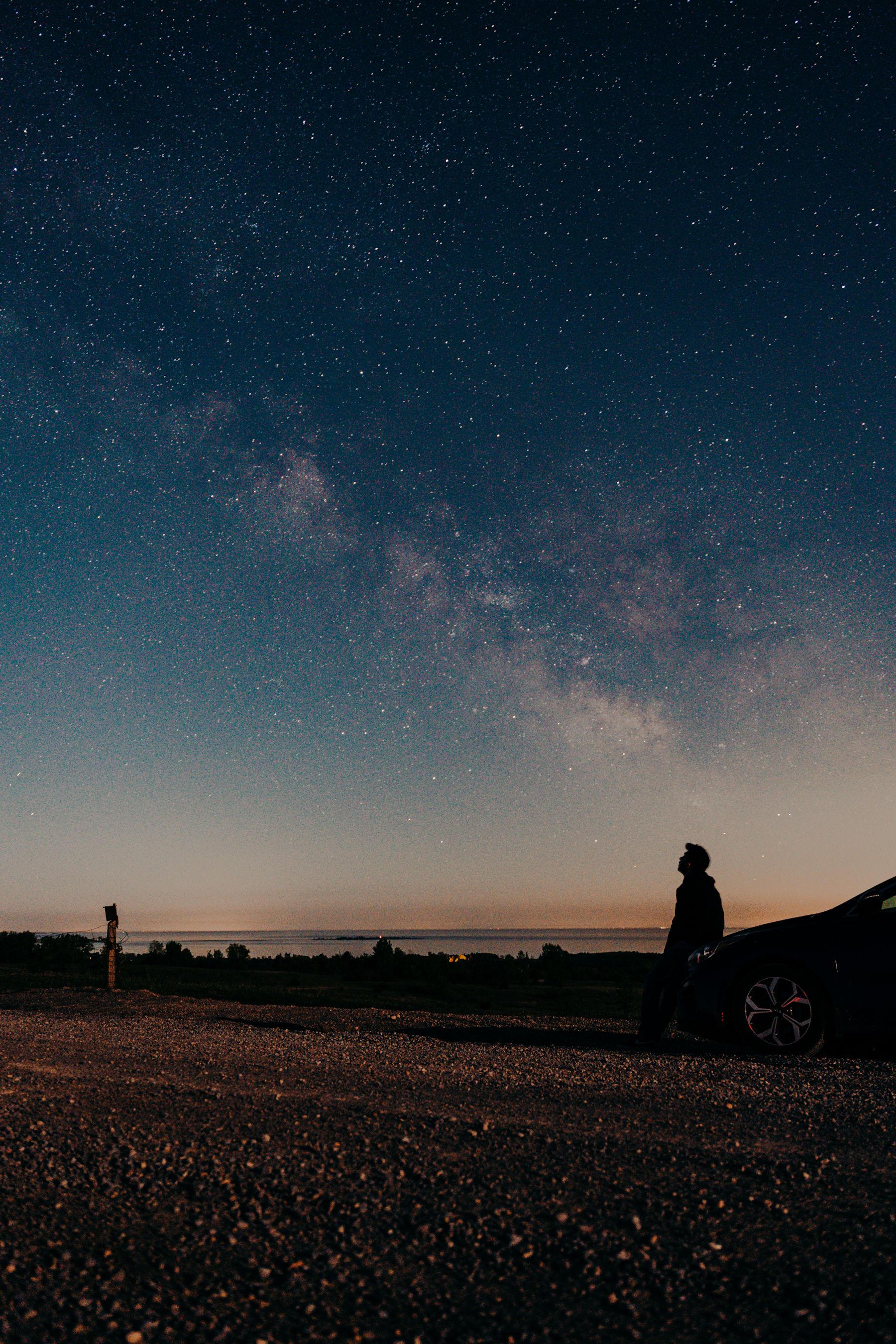 Man Standing under Stars on Clear Sky at Sunset · Free Stock Photo