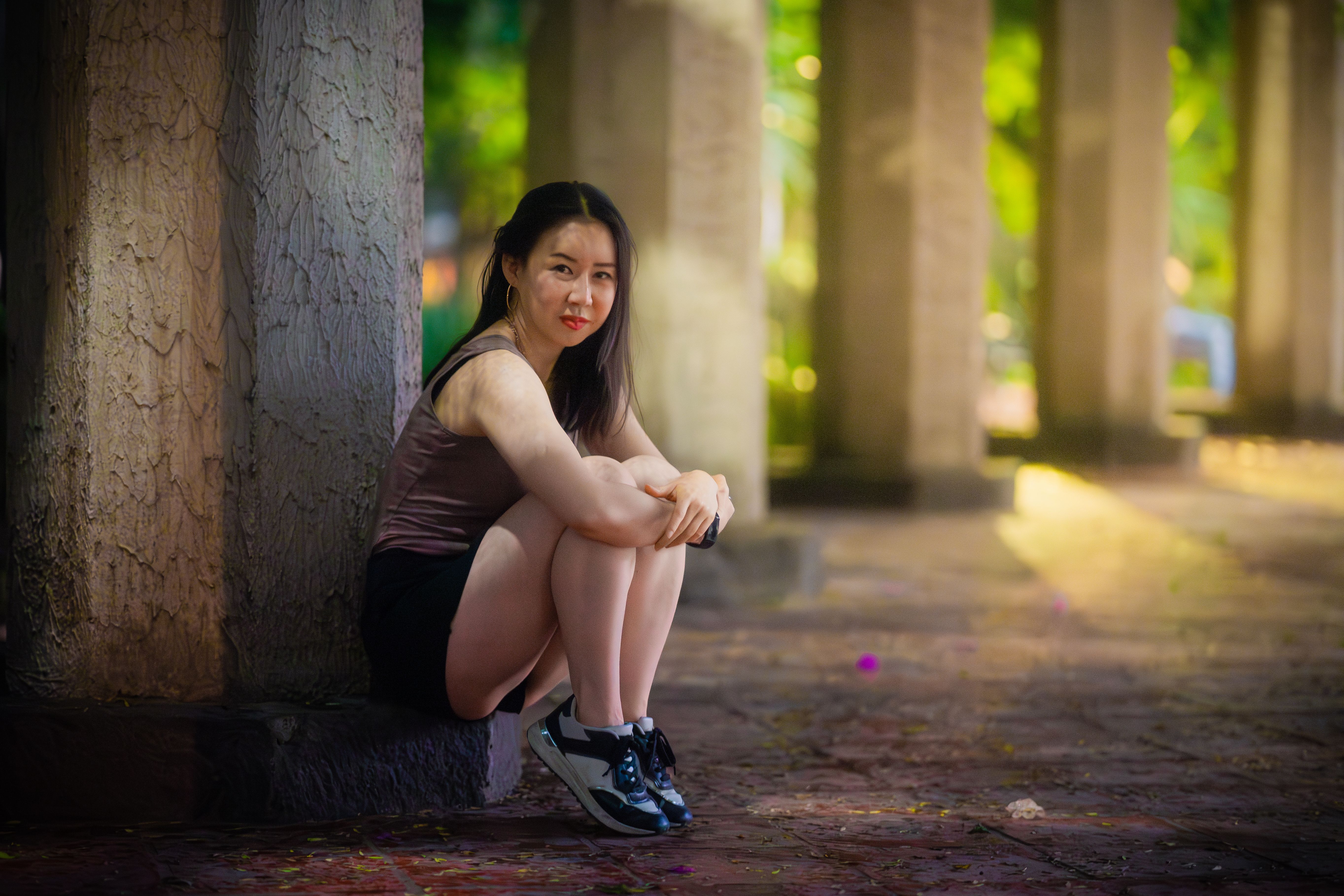 Woman Sitting and Posing by Wall · Free Stock Photo
