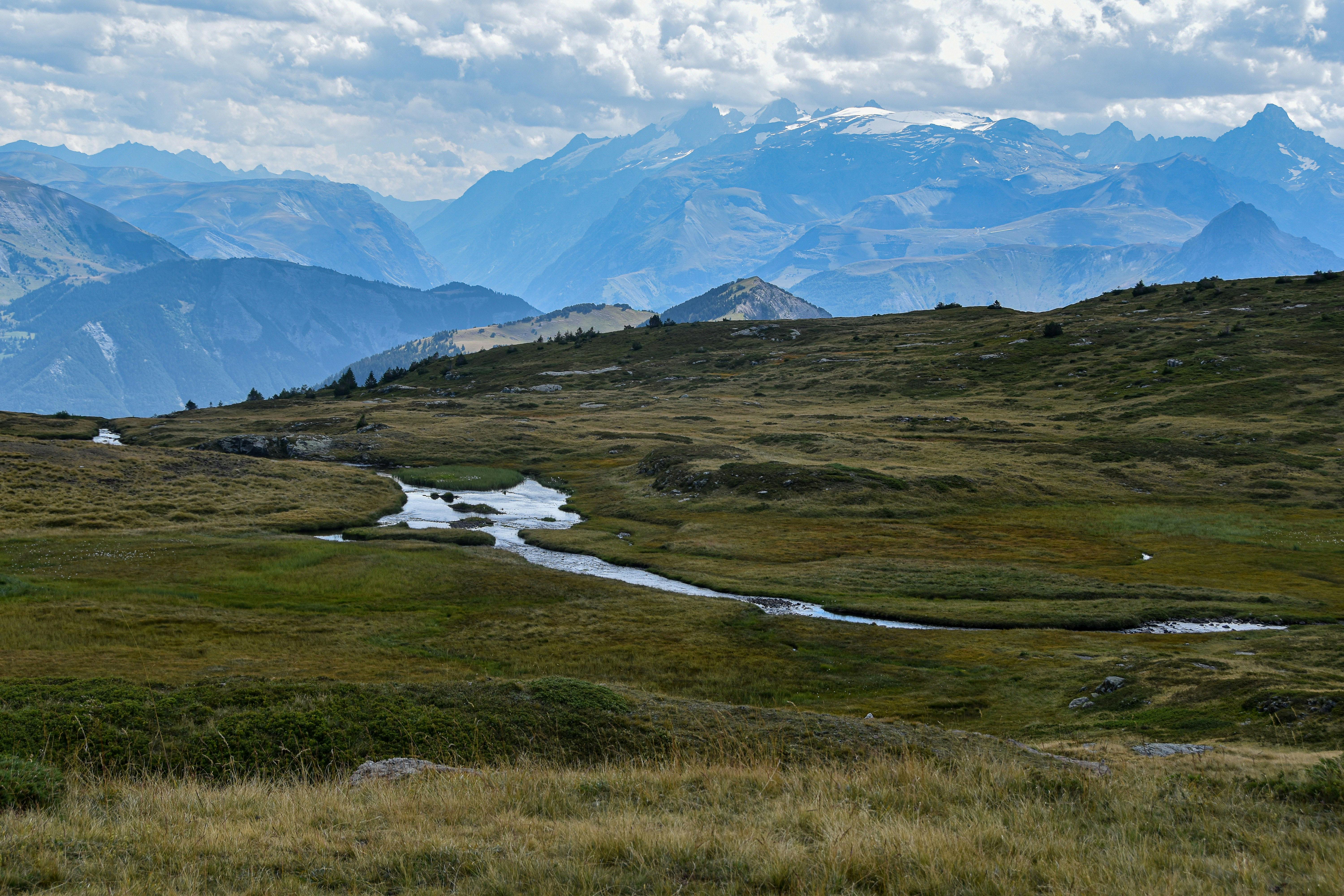 A River Flowing Through a Mountain Landscape · Free Stock Photo