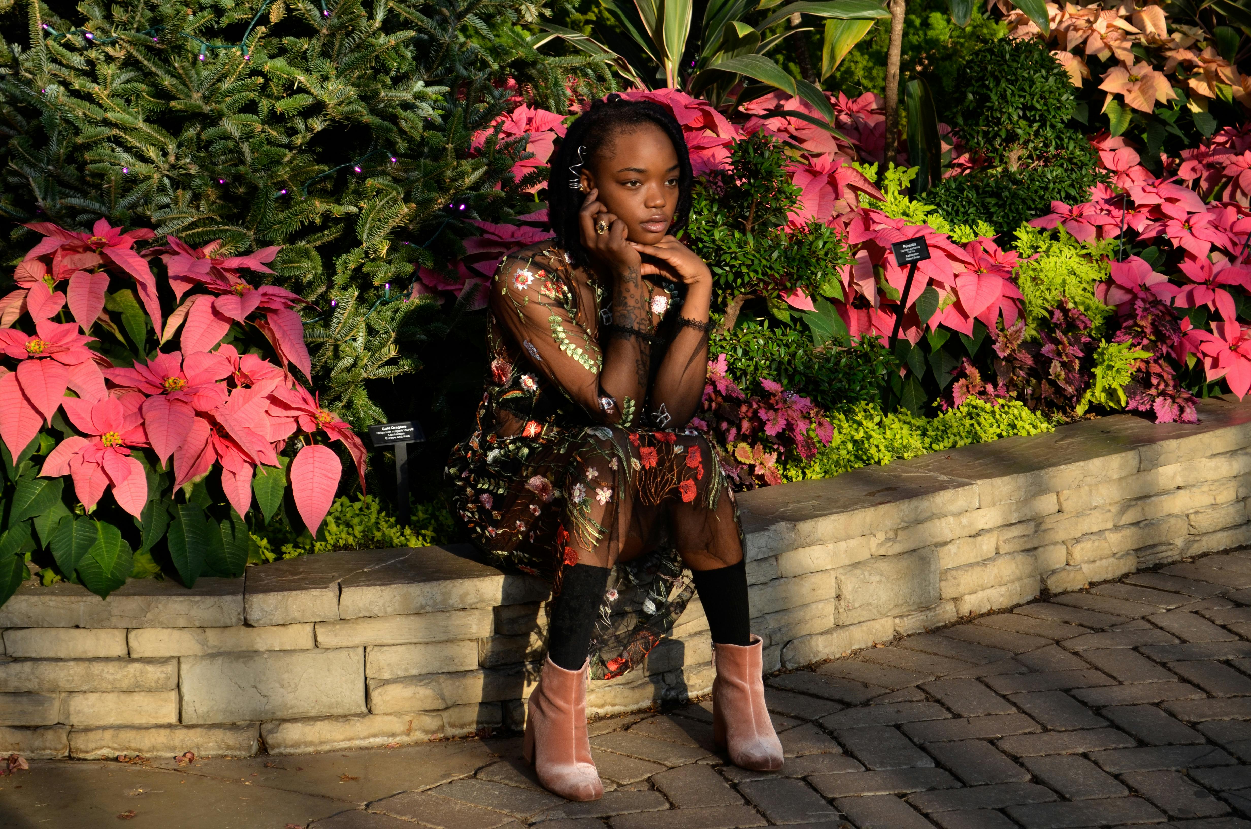 Woman Sitting on Gray Concrete Slabs · Free Stock Photo
