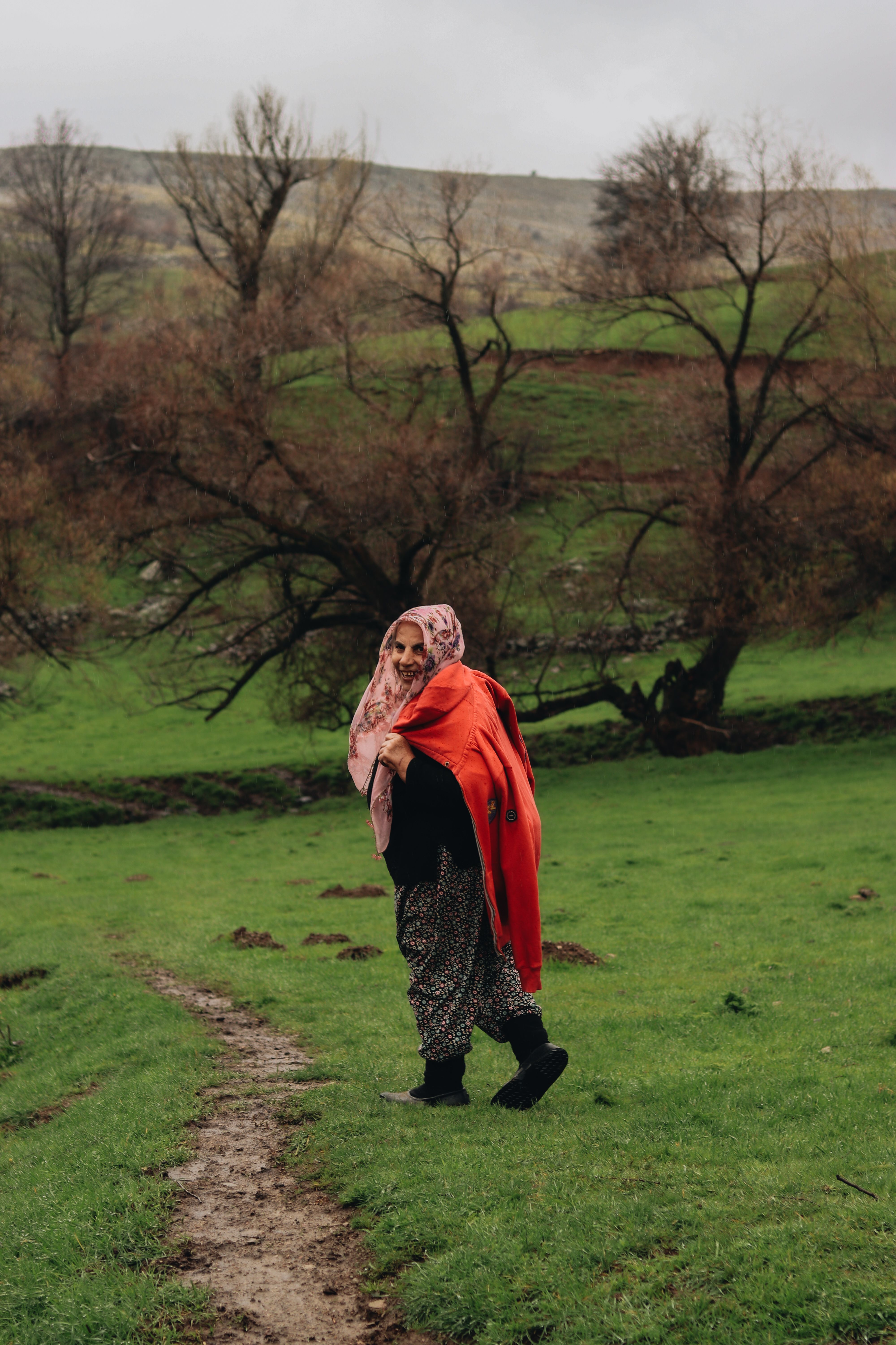 Woman Walking on a Field and Looking over Her Shoulder · Free Stock Photo