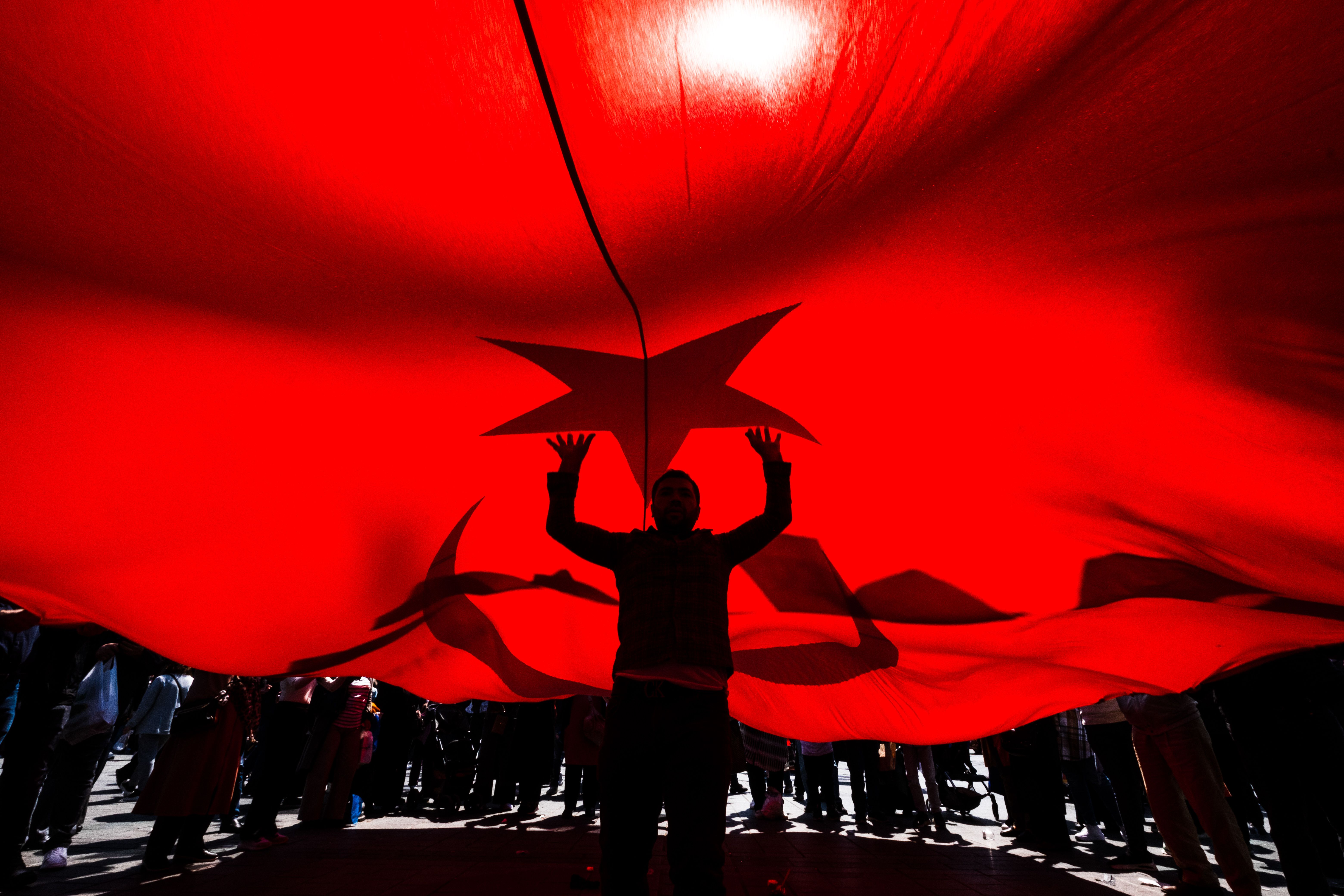 Man Standing under Flag of Turkey · Free Stock Photo
