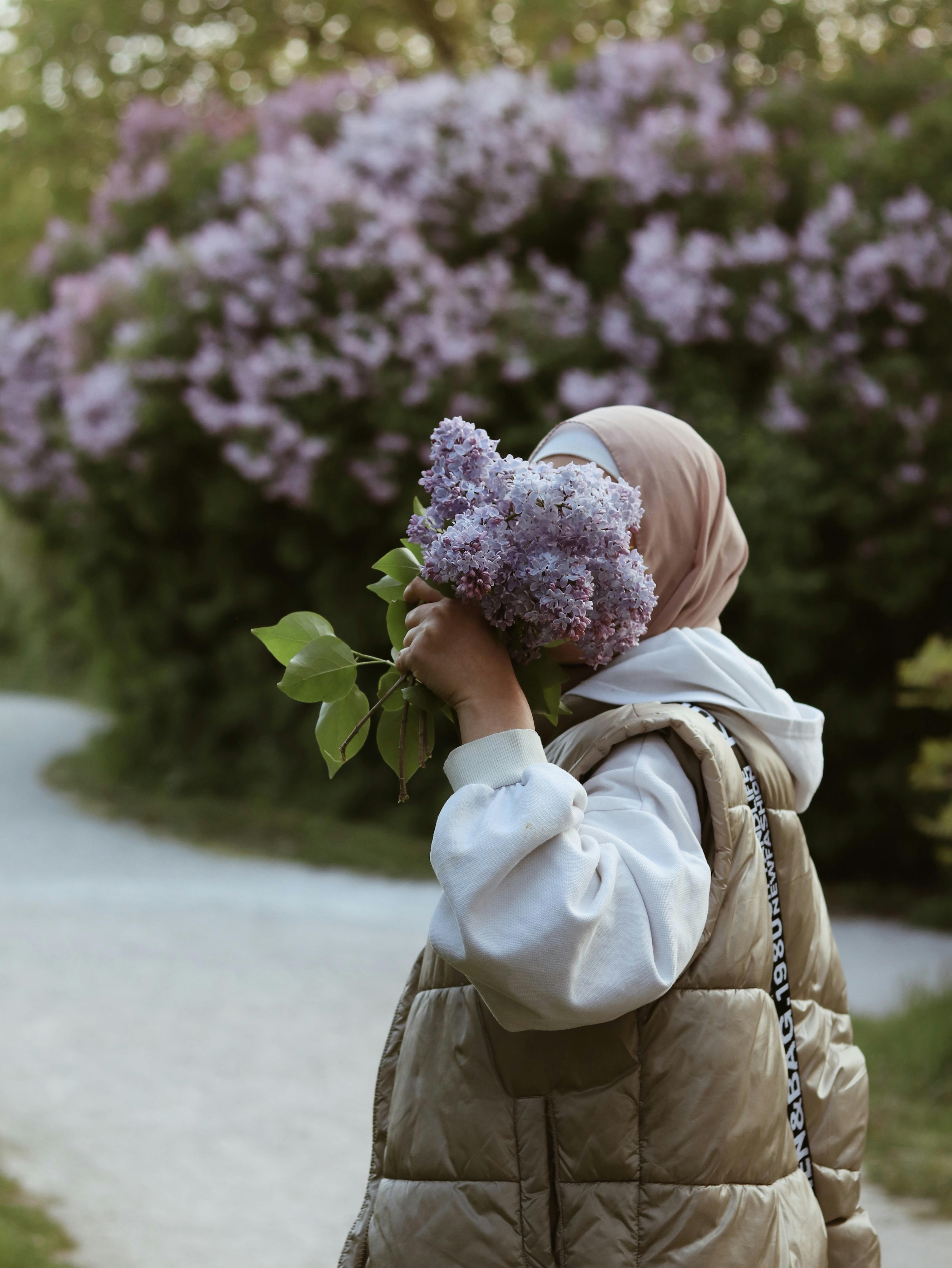 Woman in Hijab Posing with Flowers · Free Stock Photo
