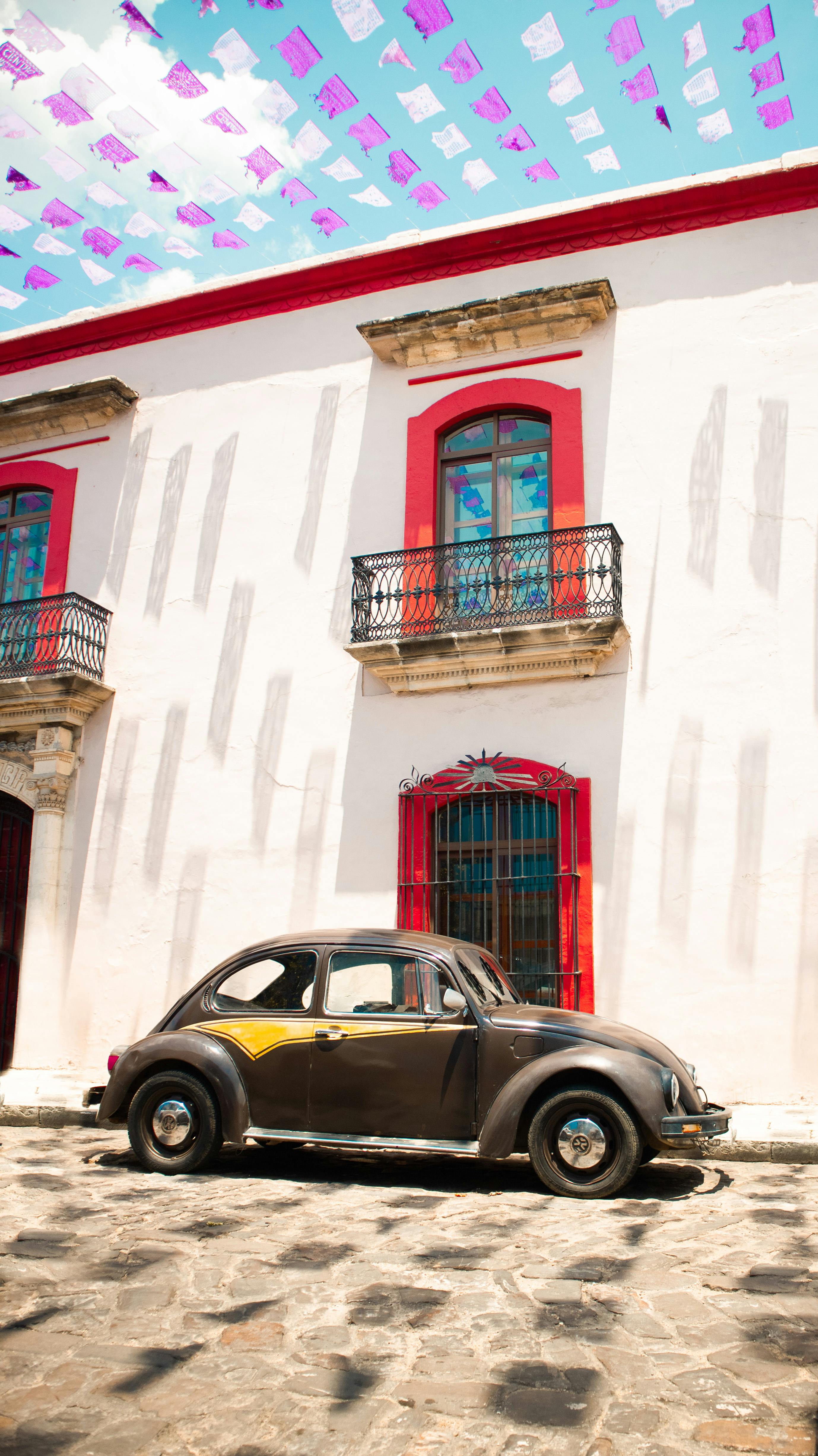 Vintage Volkswagen Beetle near Building · Free Stock Photo