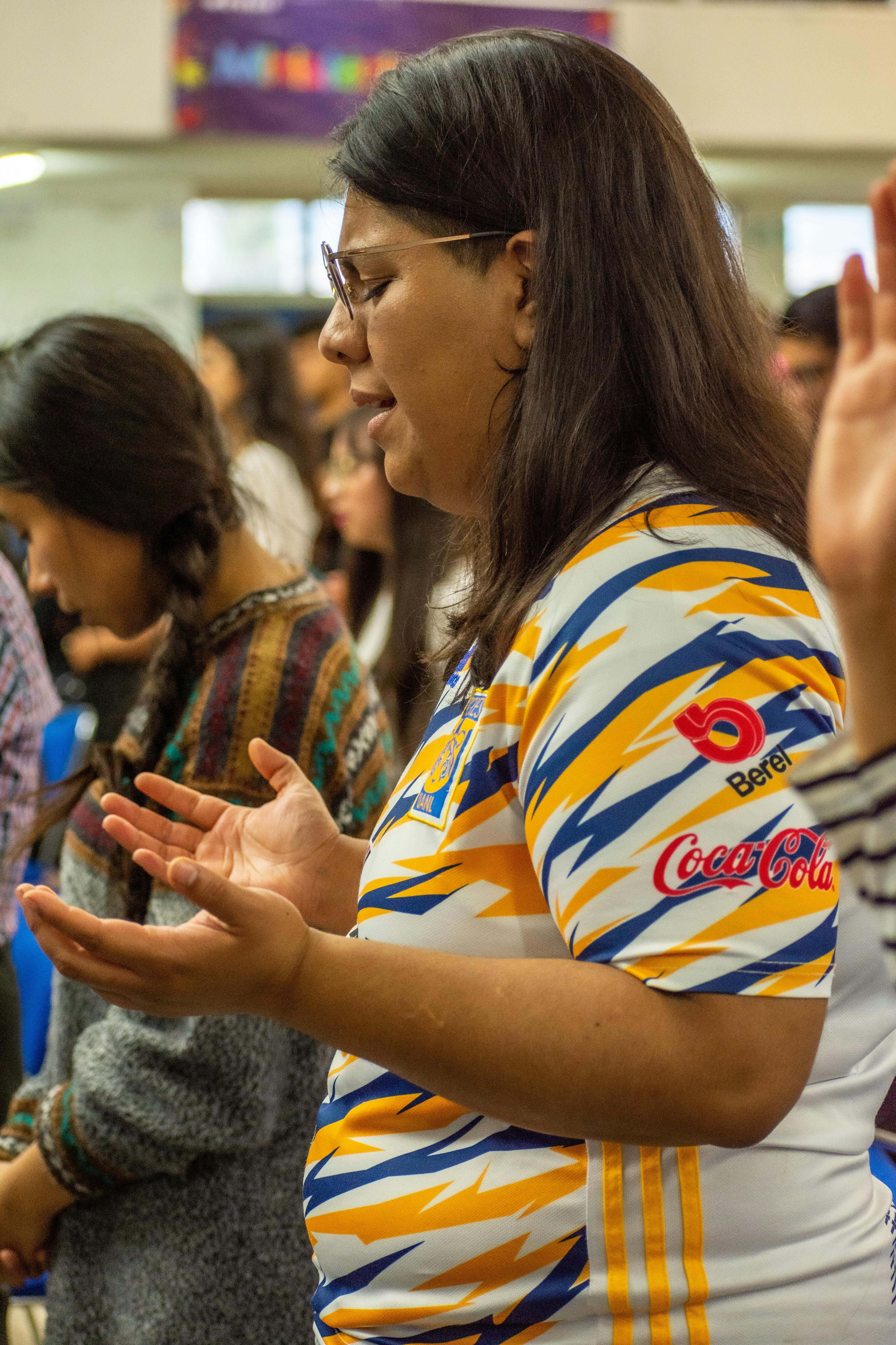 Woman Praying among People · Free Stock Photo