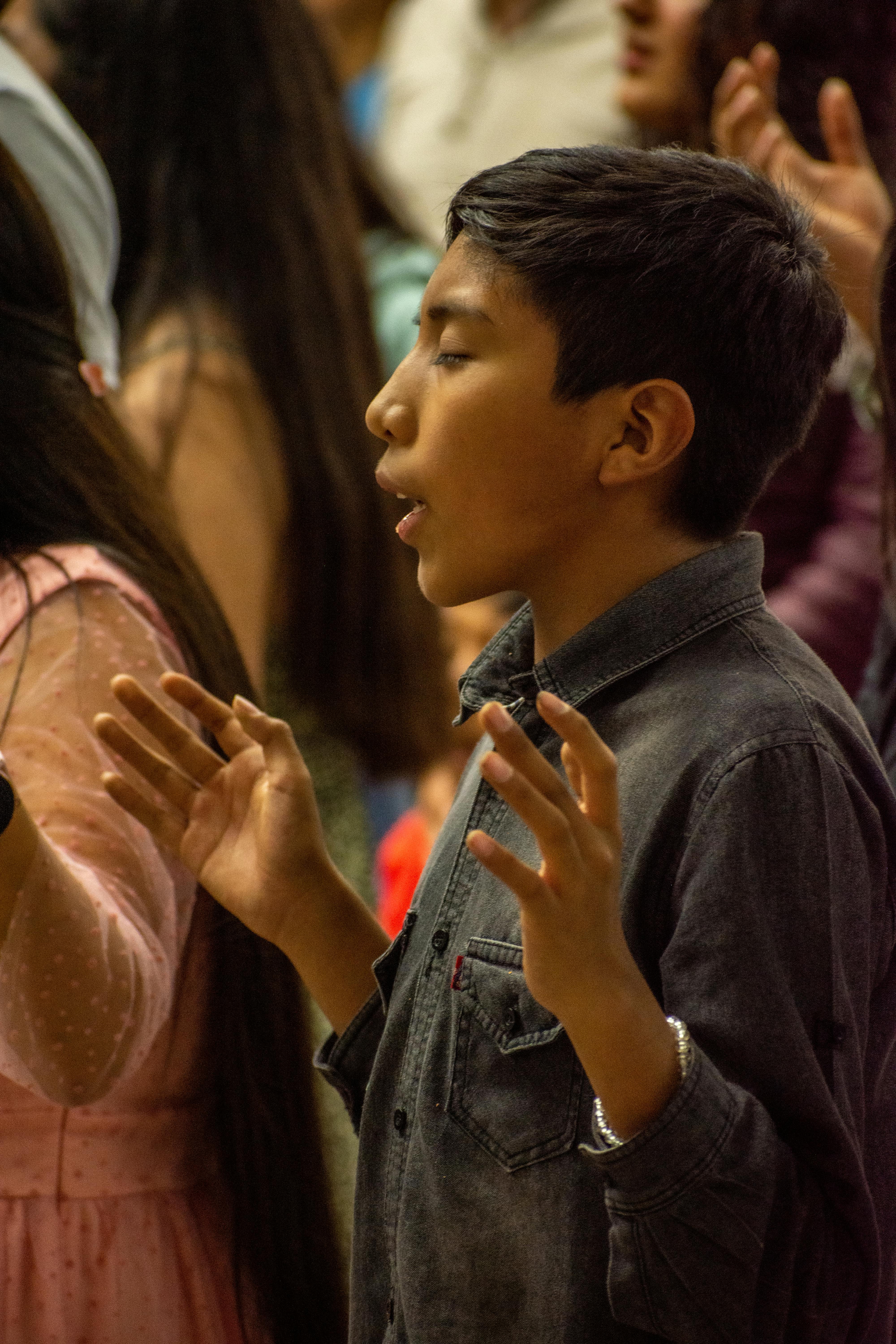 A Boy Standing in a Crowd and Preaching · Free Stock Photo