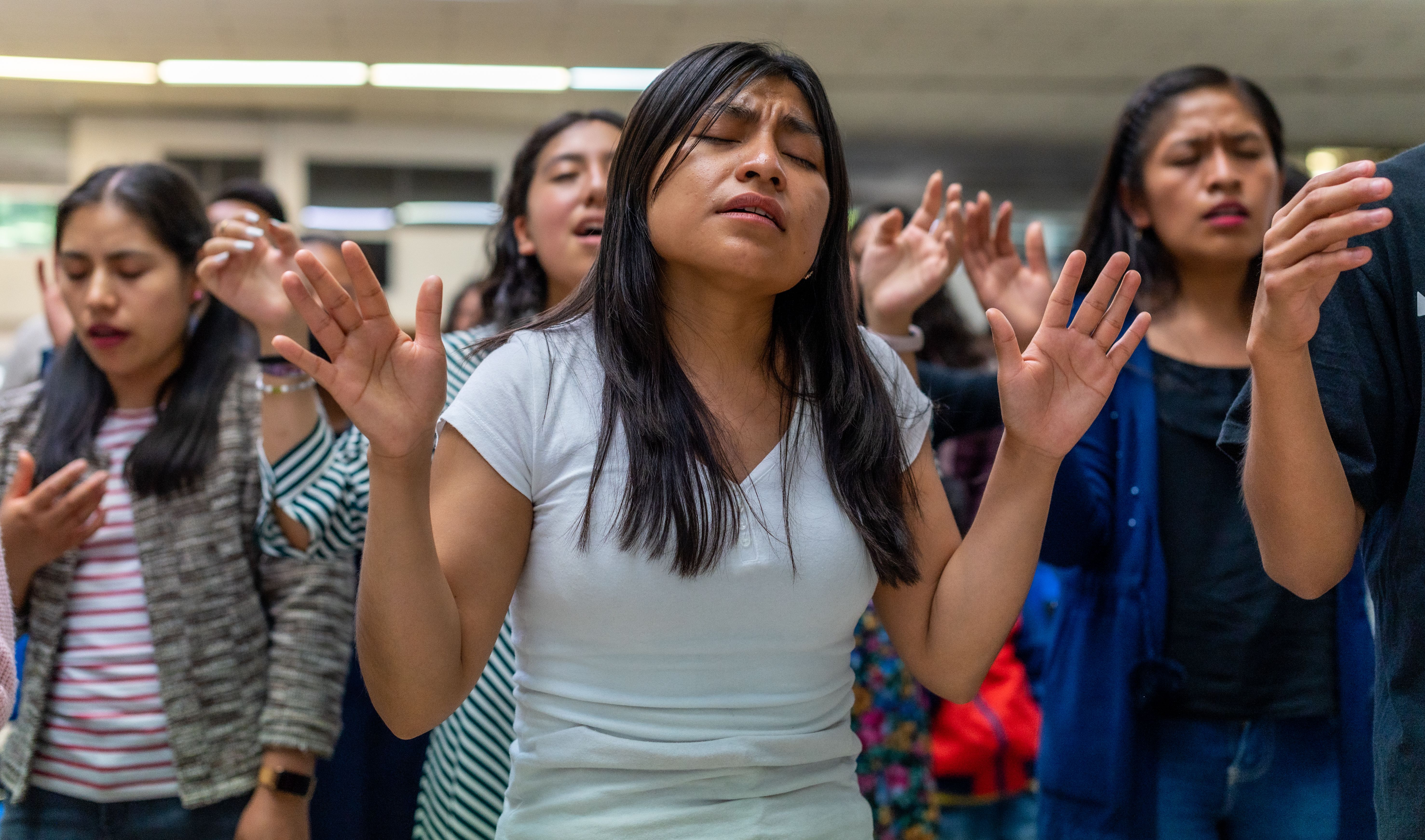 A group of women are standing in a room and clapping · Free Stock Photo
