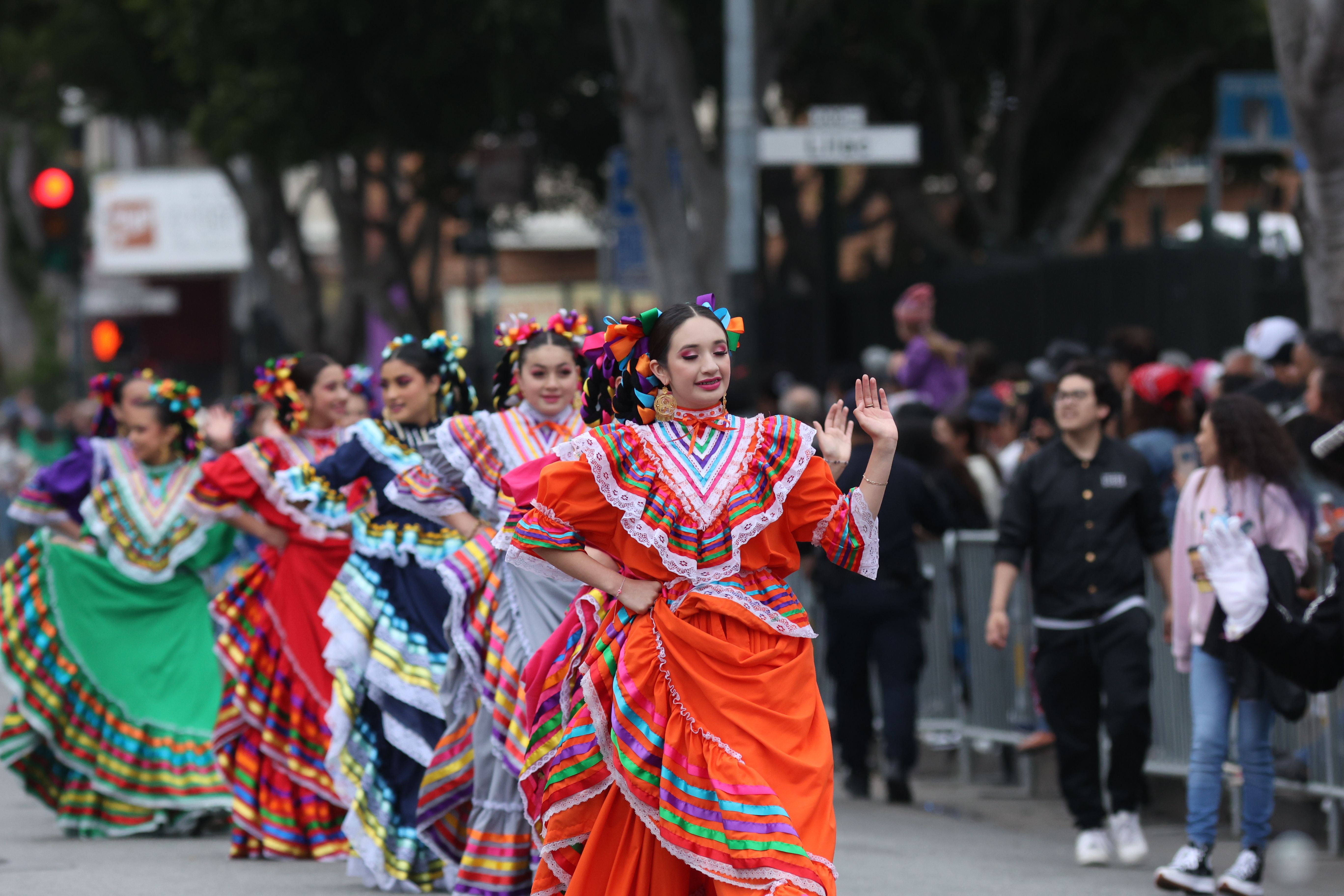 Women in Costumes Dancing on a Street · Free Stock Photo