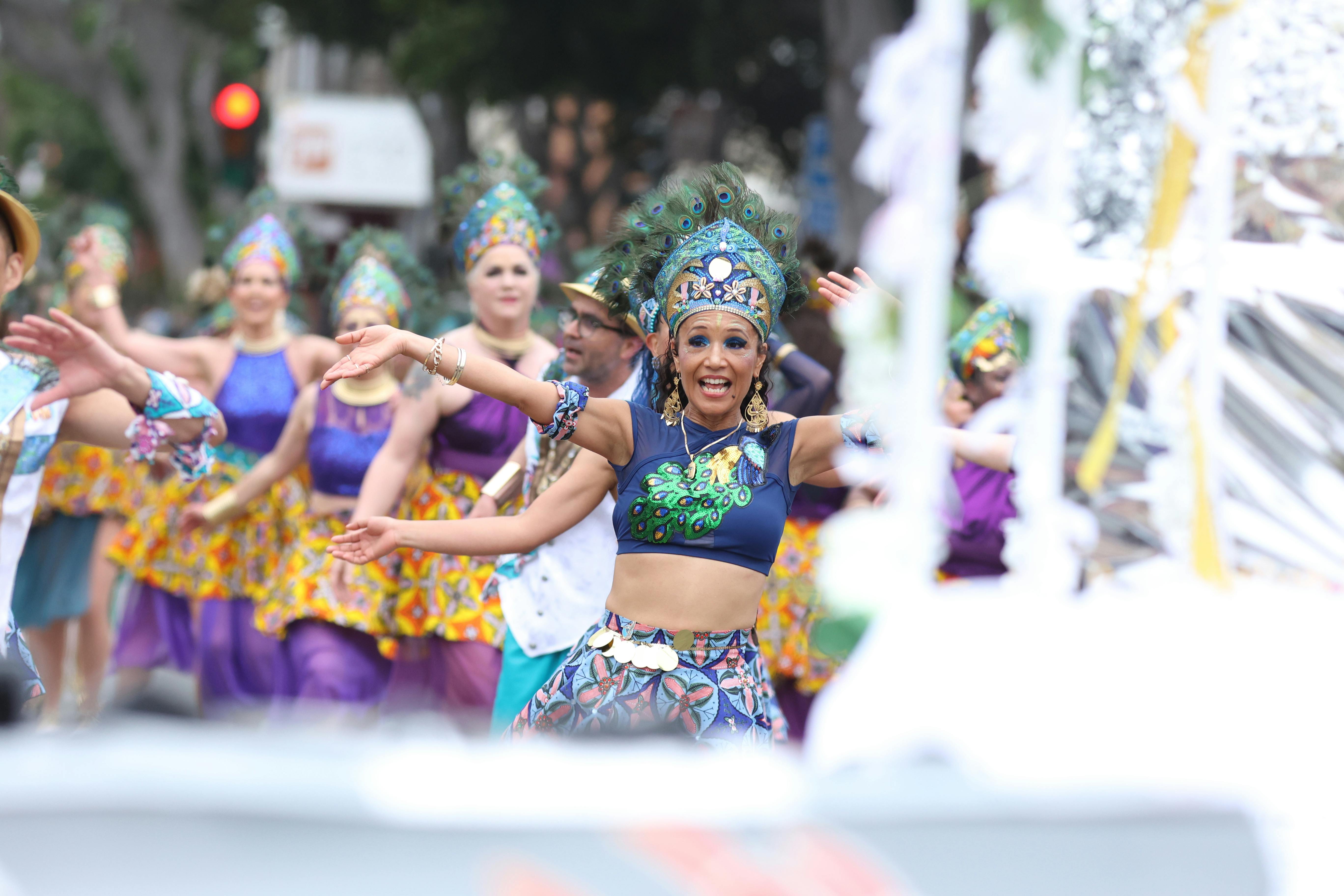 A Group of Dancers in Traditional Clothing at a Parade during a ...