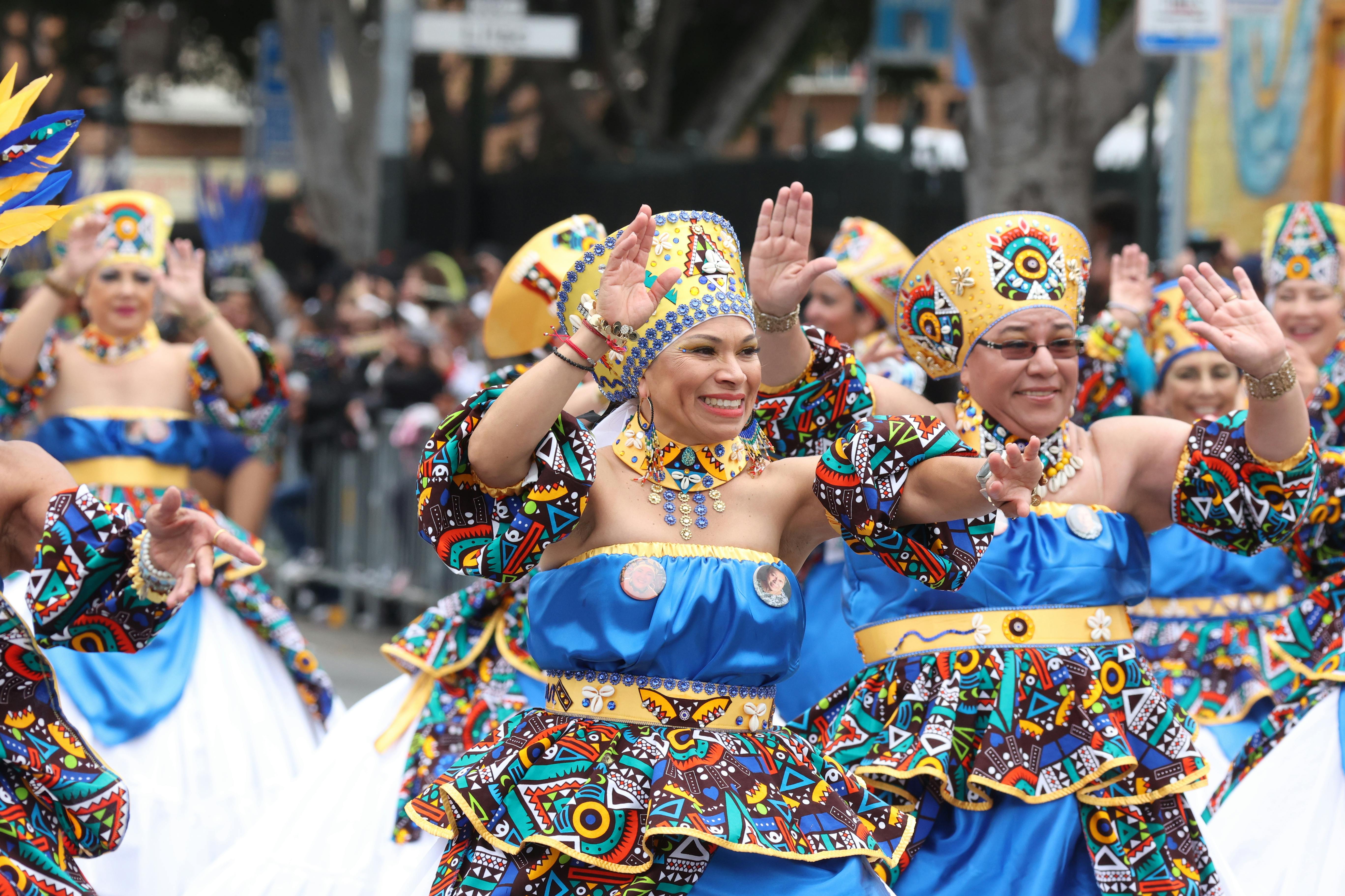 A Group of Dancers in Traditional Clothing at a Parade during a ...